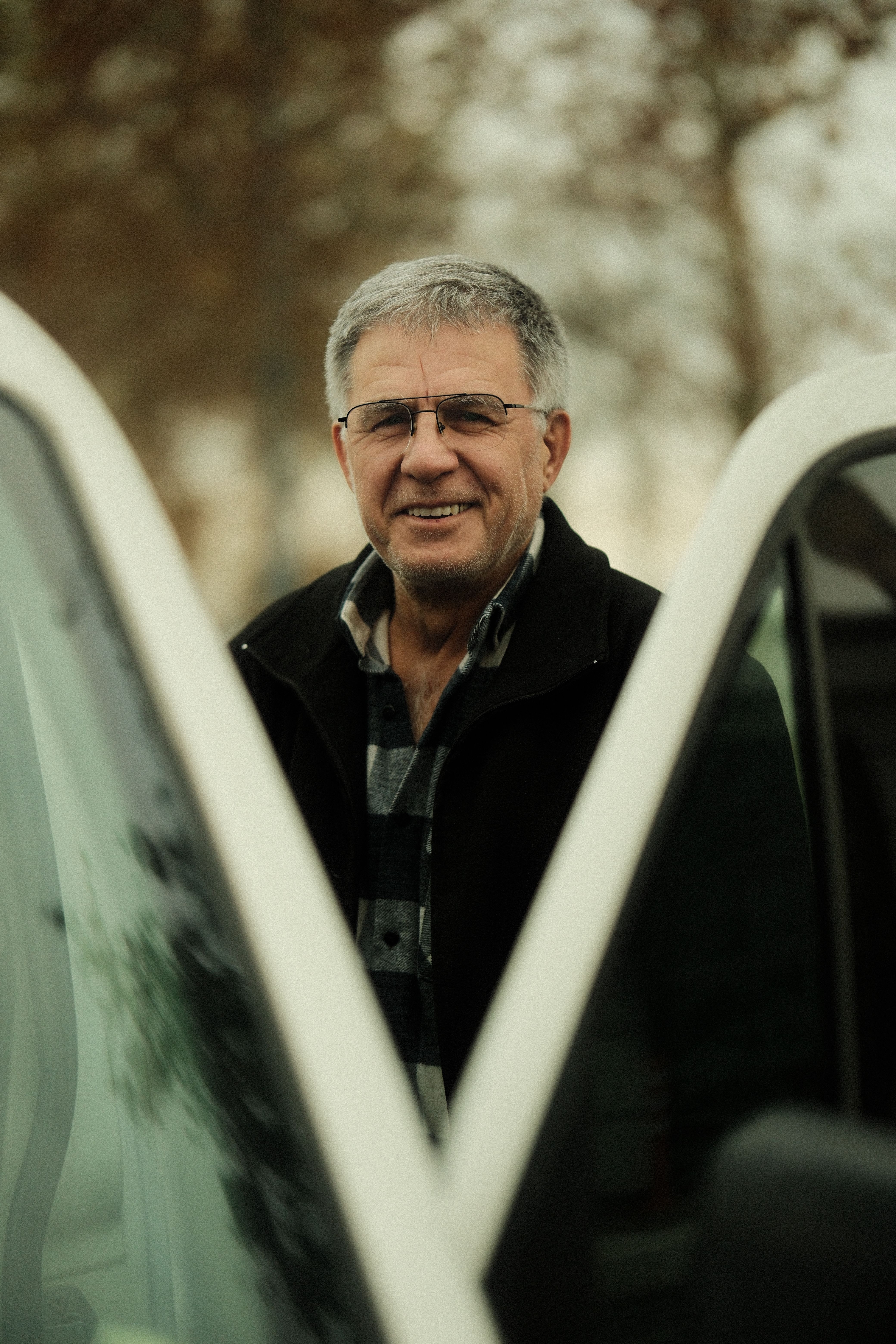 Senior Man Smiling Between Car Doors · Free Stock Photo
