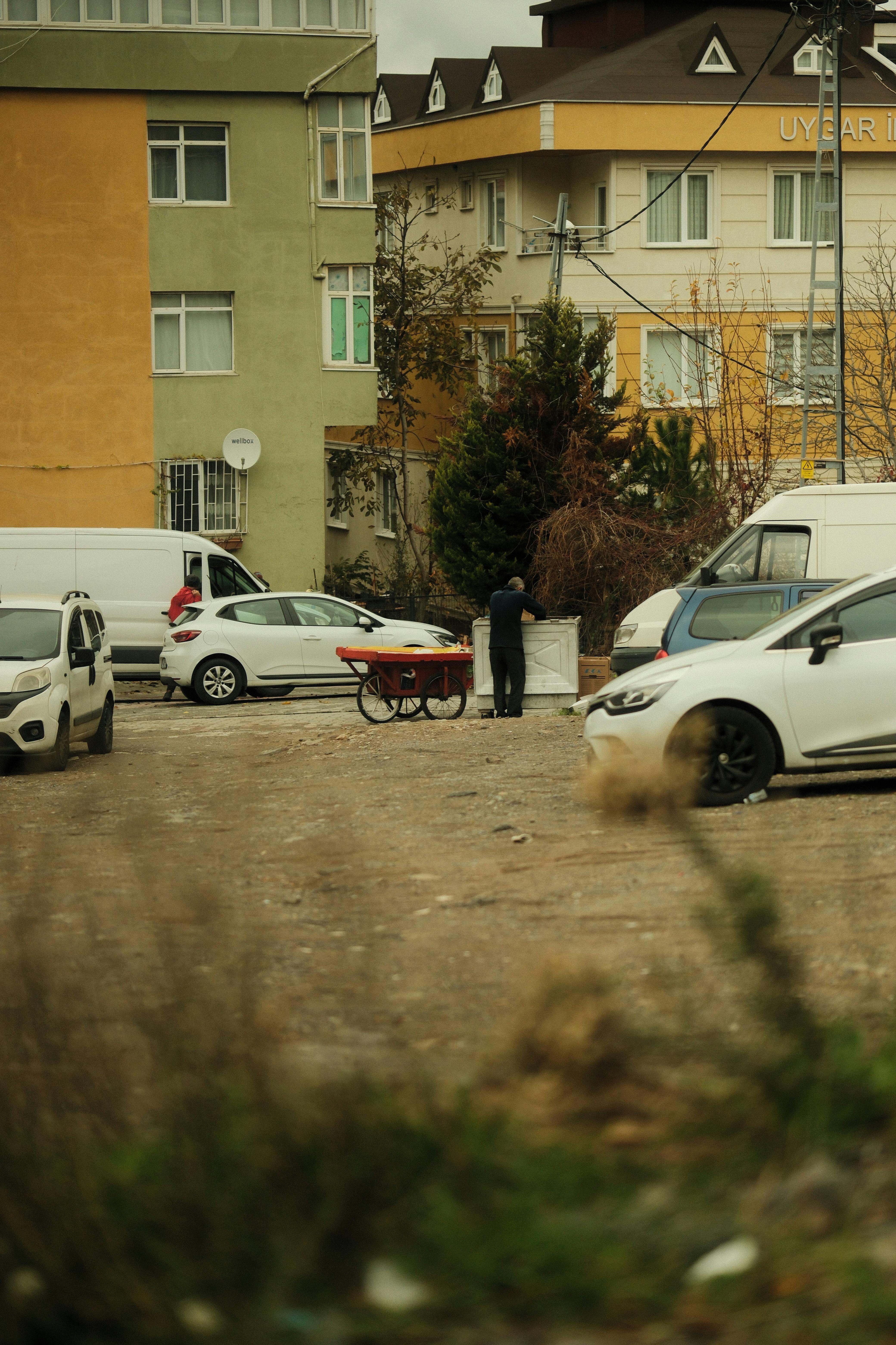 Urban Scene with Person and Wheelbarrow · Free Stock Photo