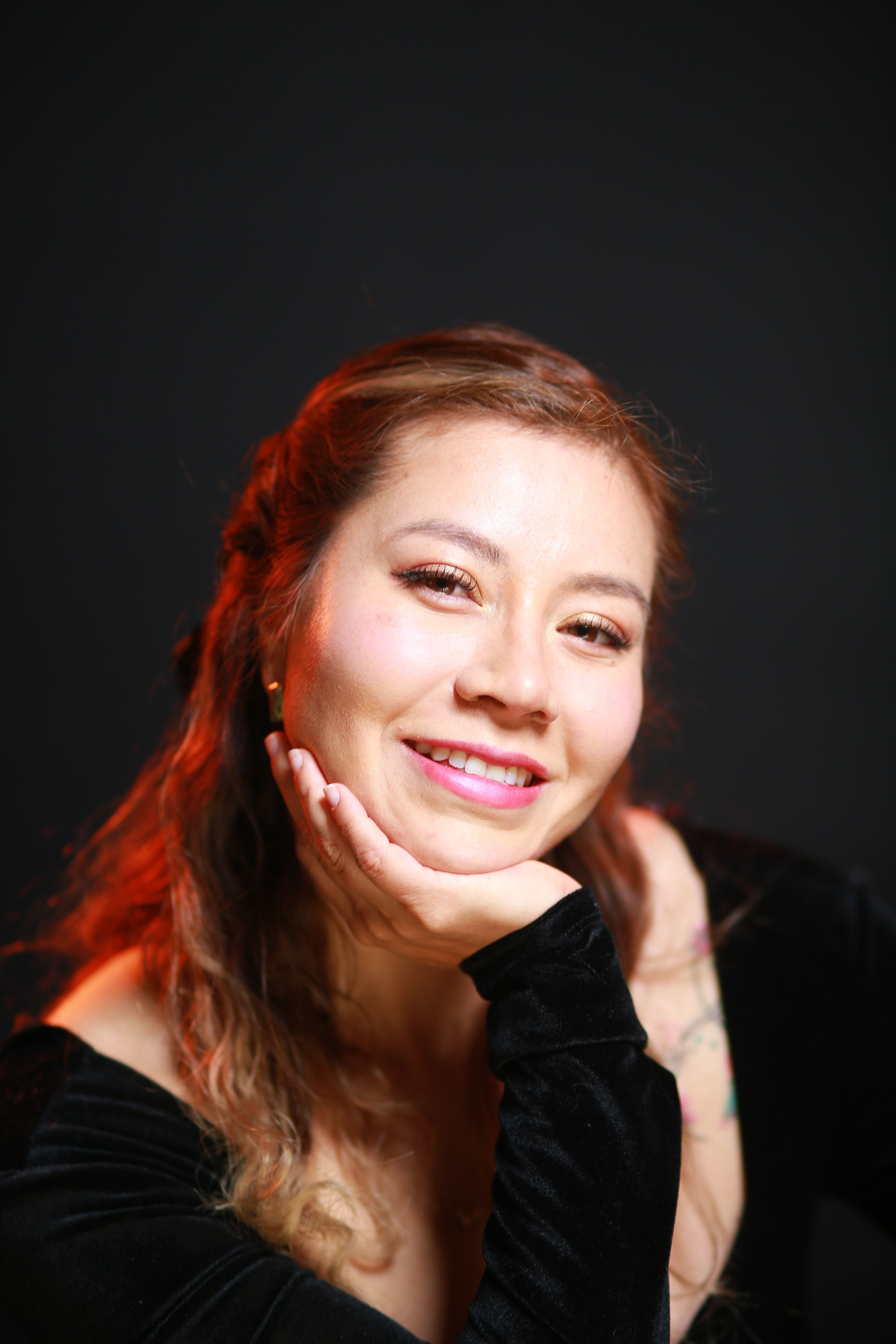 Portrait of a Smiling Woman with Warm Lighting · Free Stock Photo