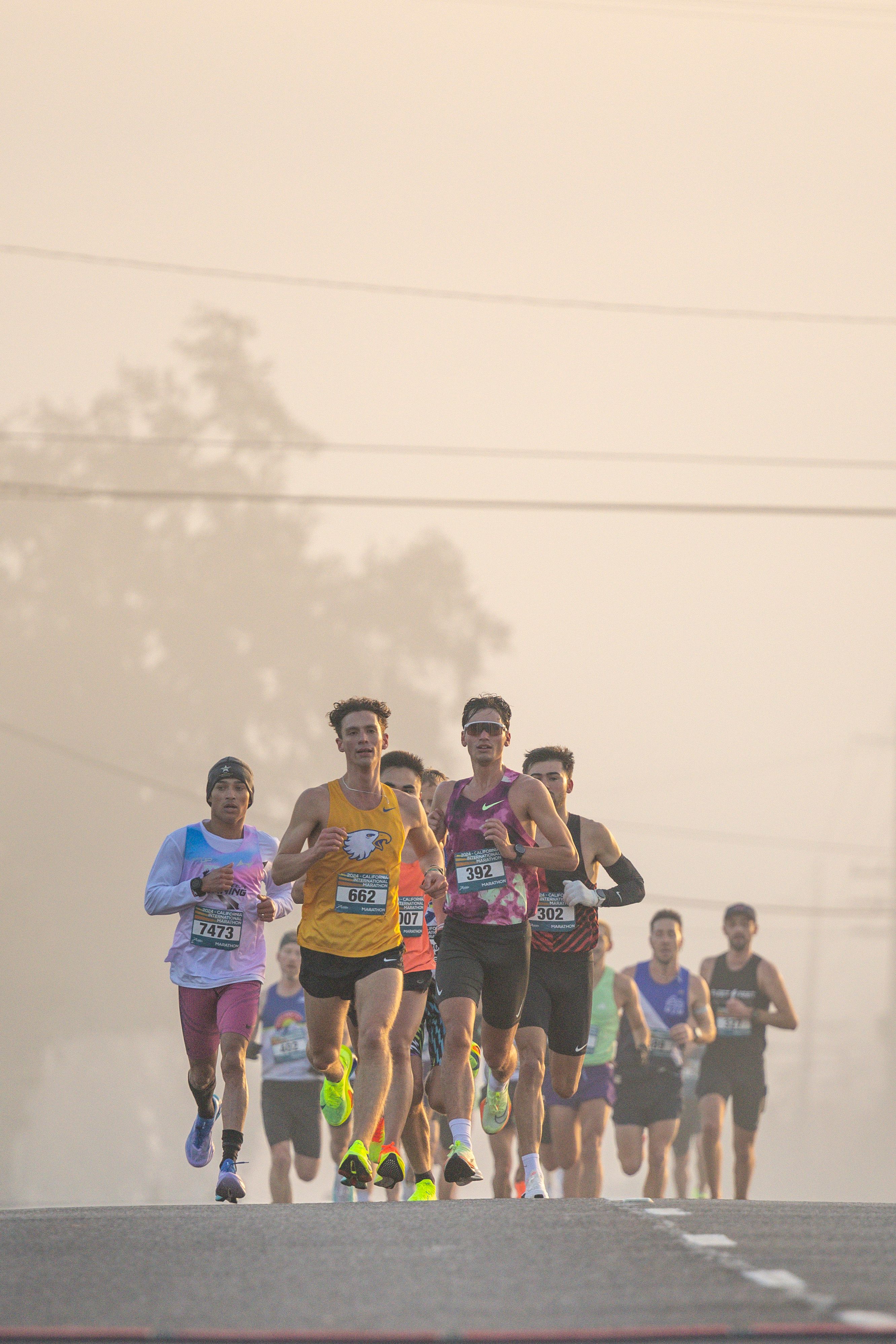 Group of Marathon Runners in Early Morning Fog · Free Stock Photo
