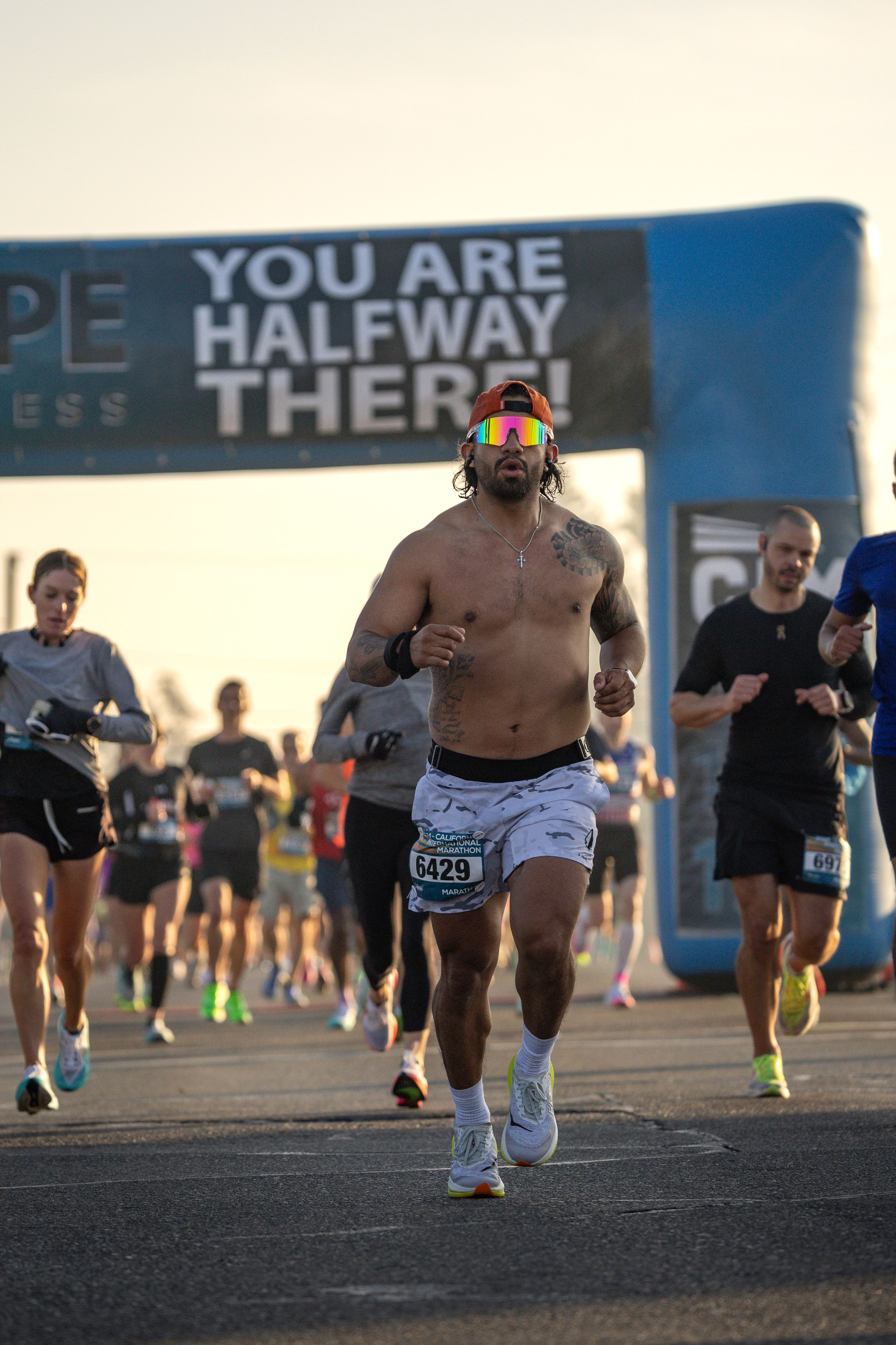Marathon Runners Passing Halfway Point Banner · Free Stock Photo
