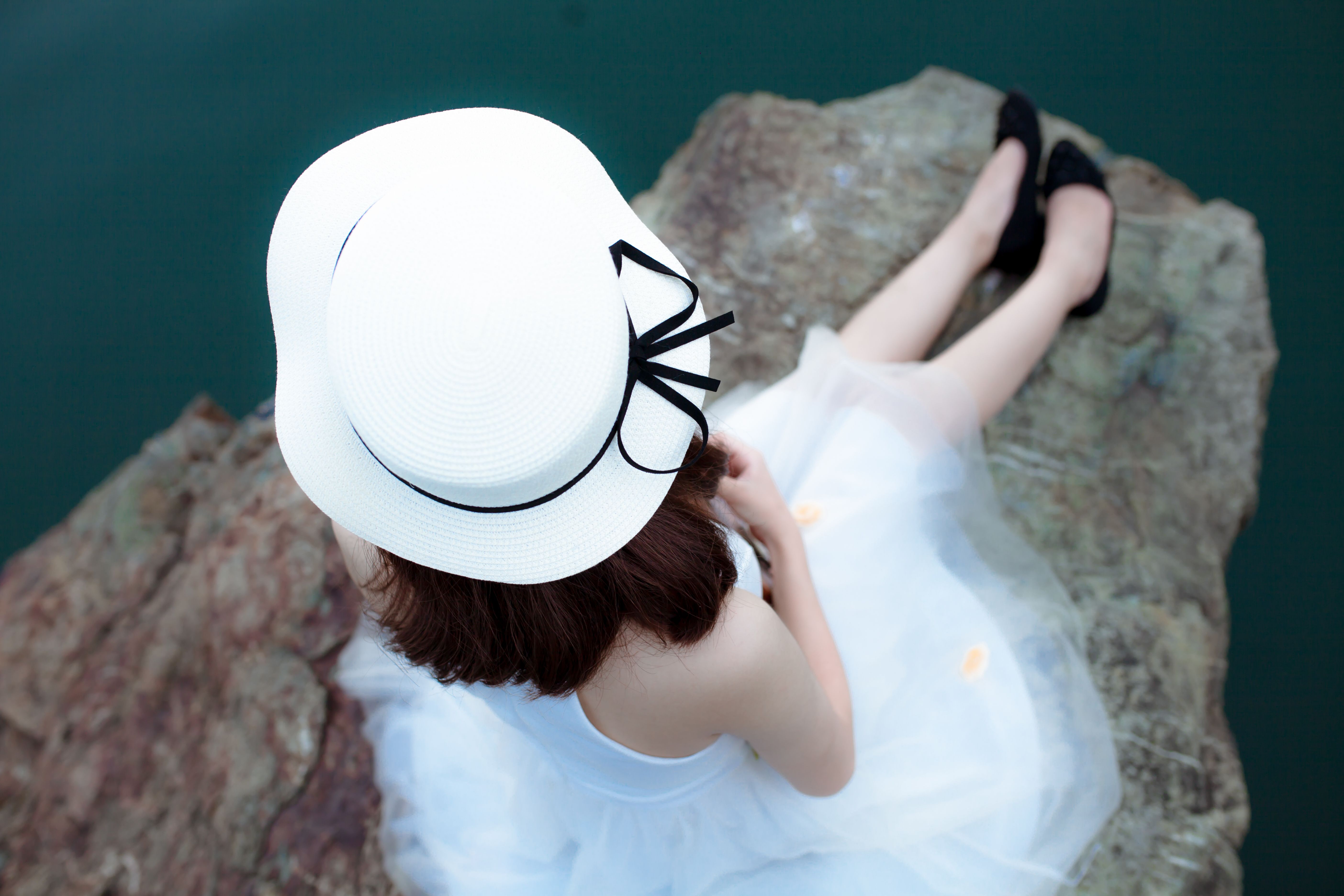 Elegant Woman in White Hat by Riverside · Free Stock Photo