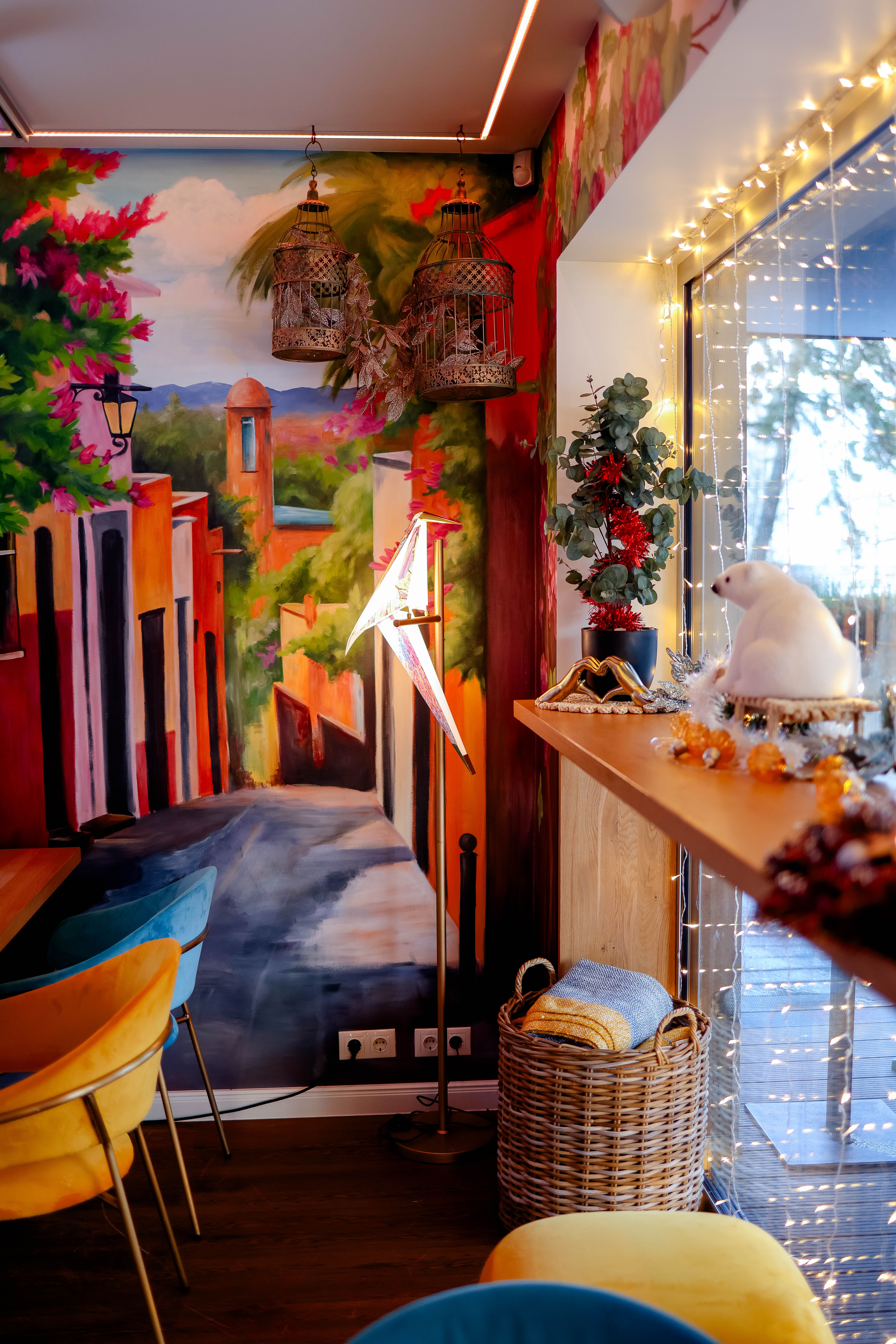 Cozy Cafe Corner with Vibrant Wall Mural · Free Stock Photo