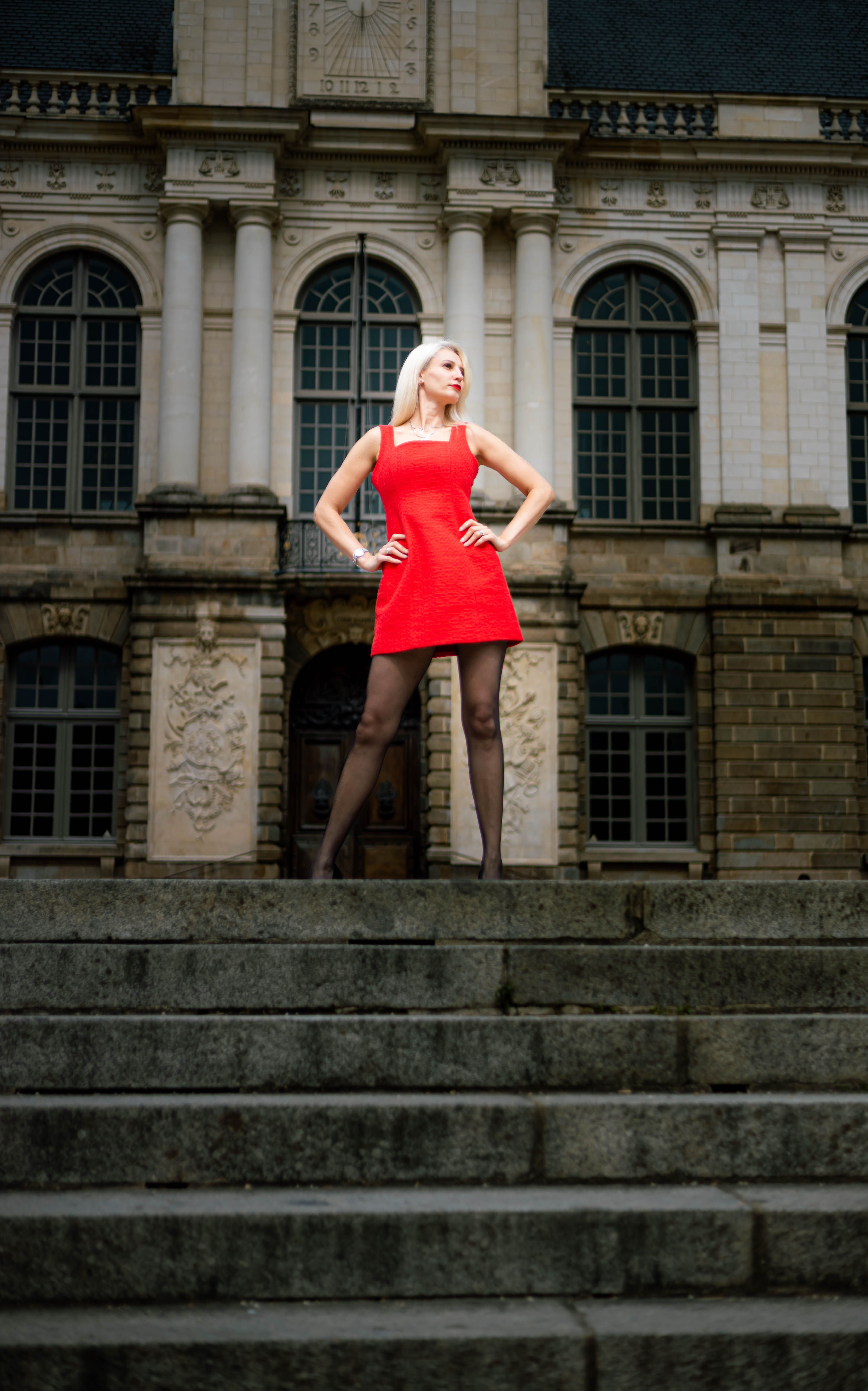 Woman Posing in Red Dress on Historic Steps · Free Stock Photo