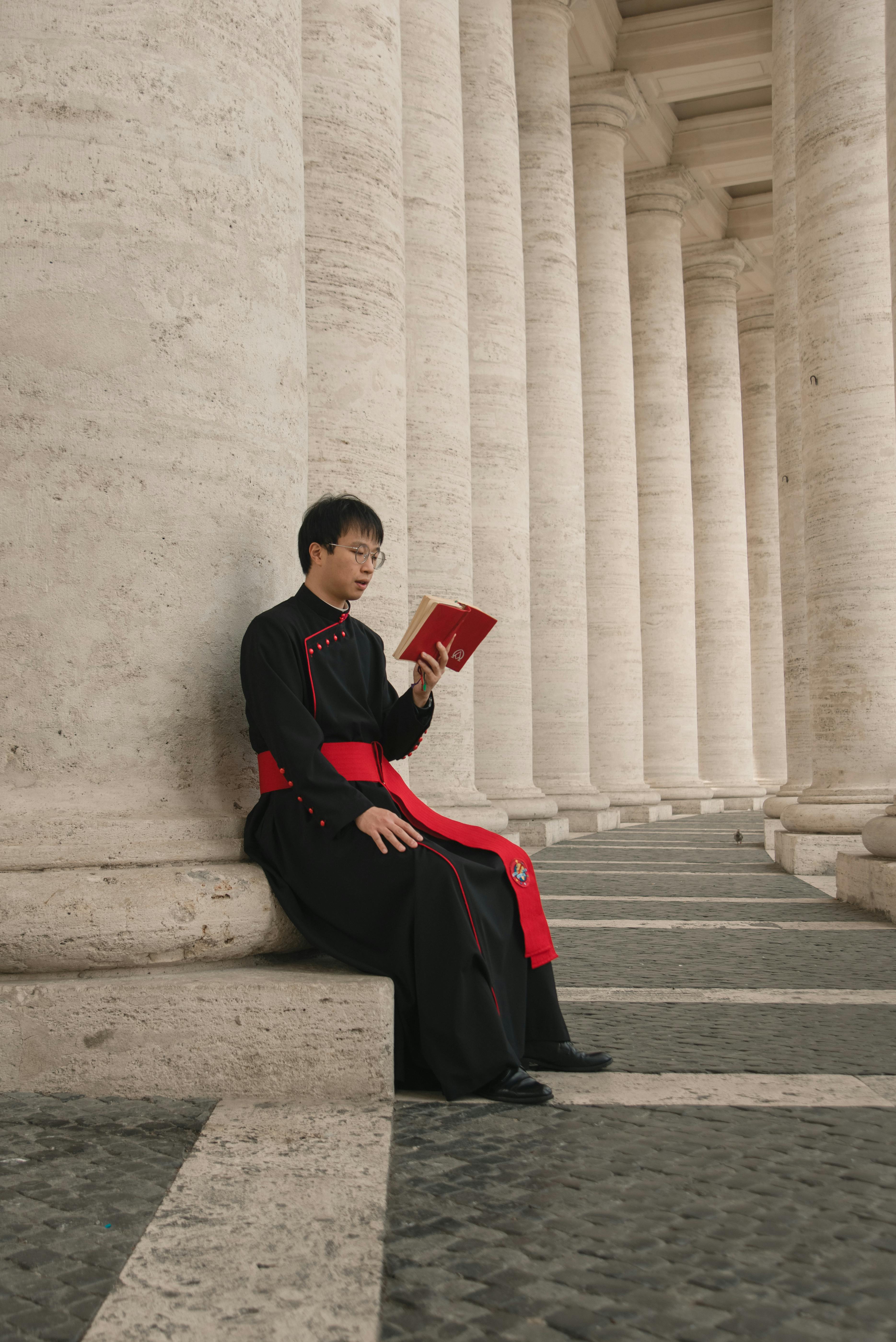 Priest Reading by Vatican Columns Outdoors · Free Stock Photo