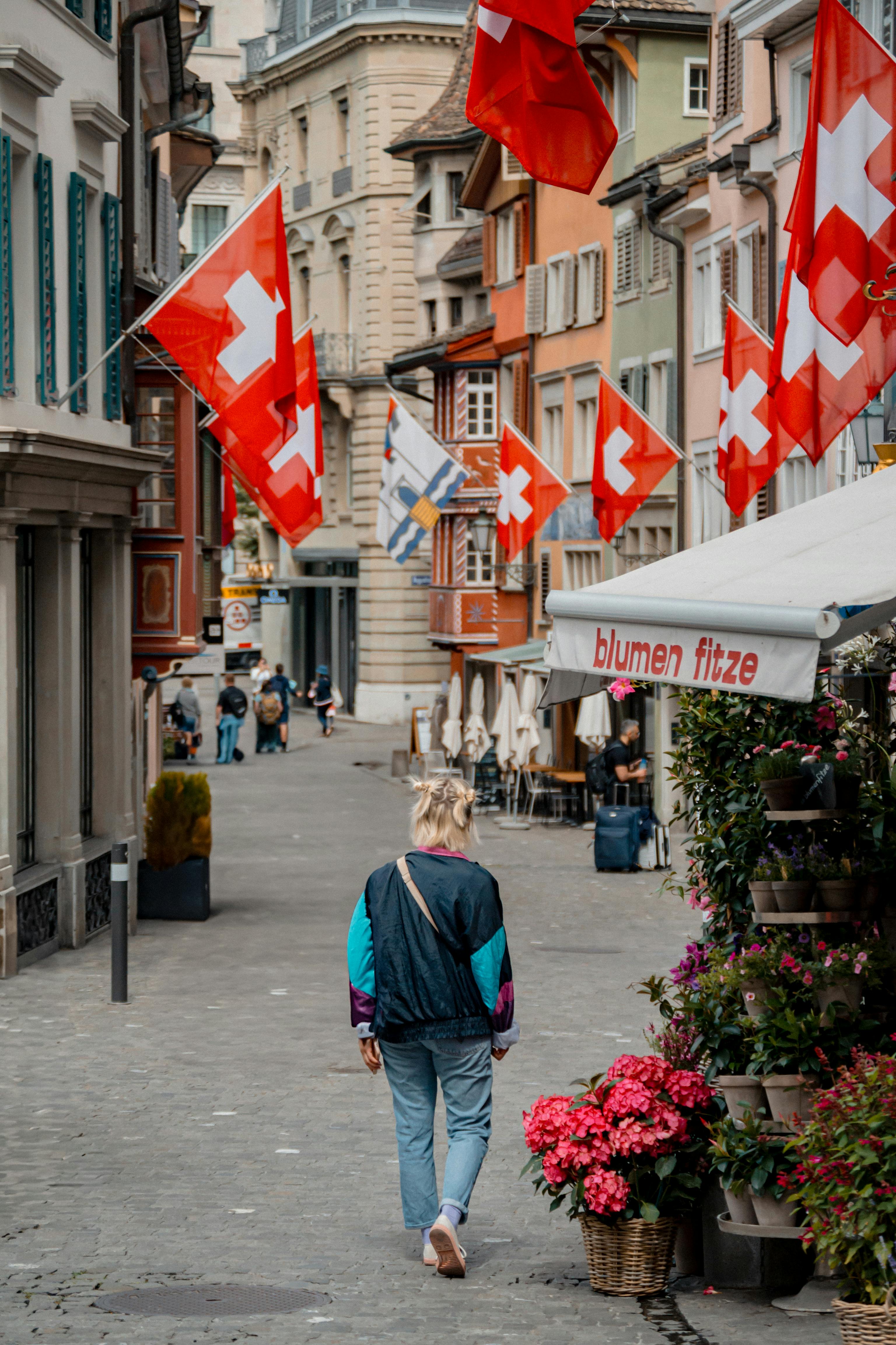 Charming Zurich Old Town with Swiss Flags · Free Stock Photo