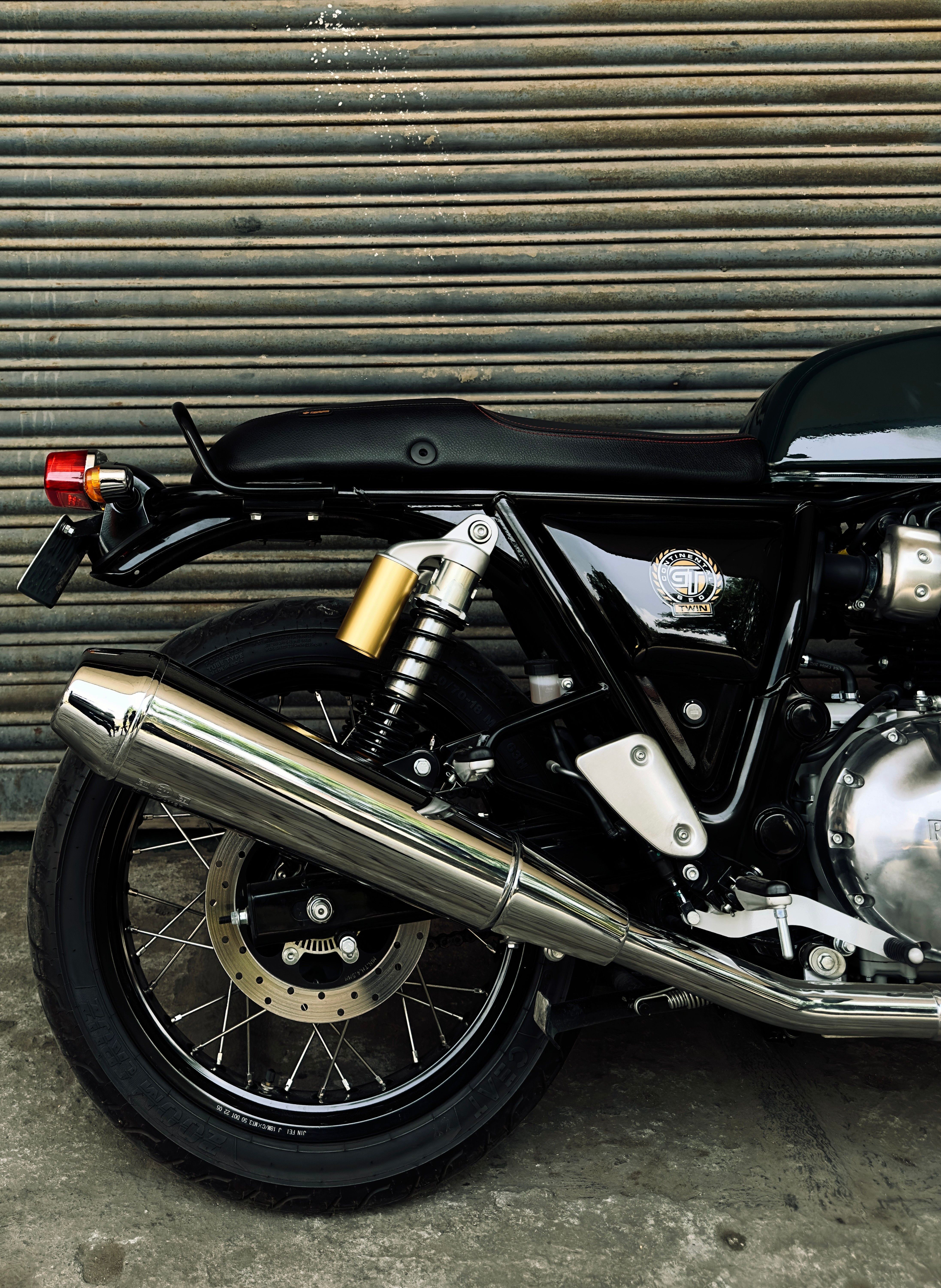 Close-up of a Classic Motorcycle Exhaust and Rear Wheel · Free Stock Photo