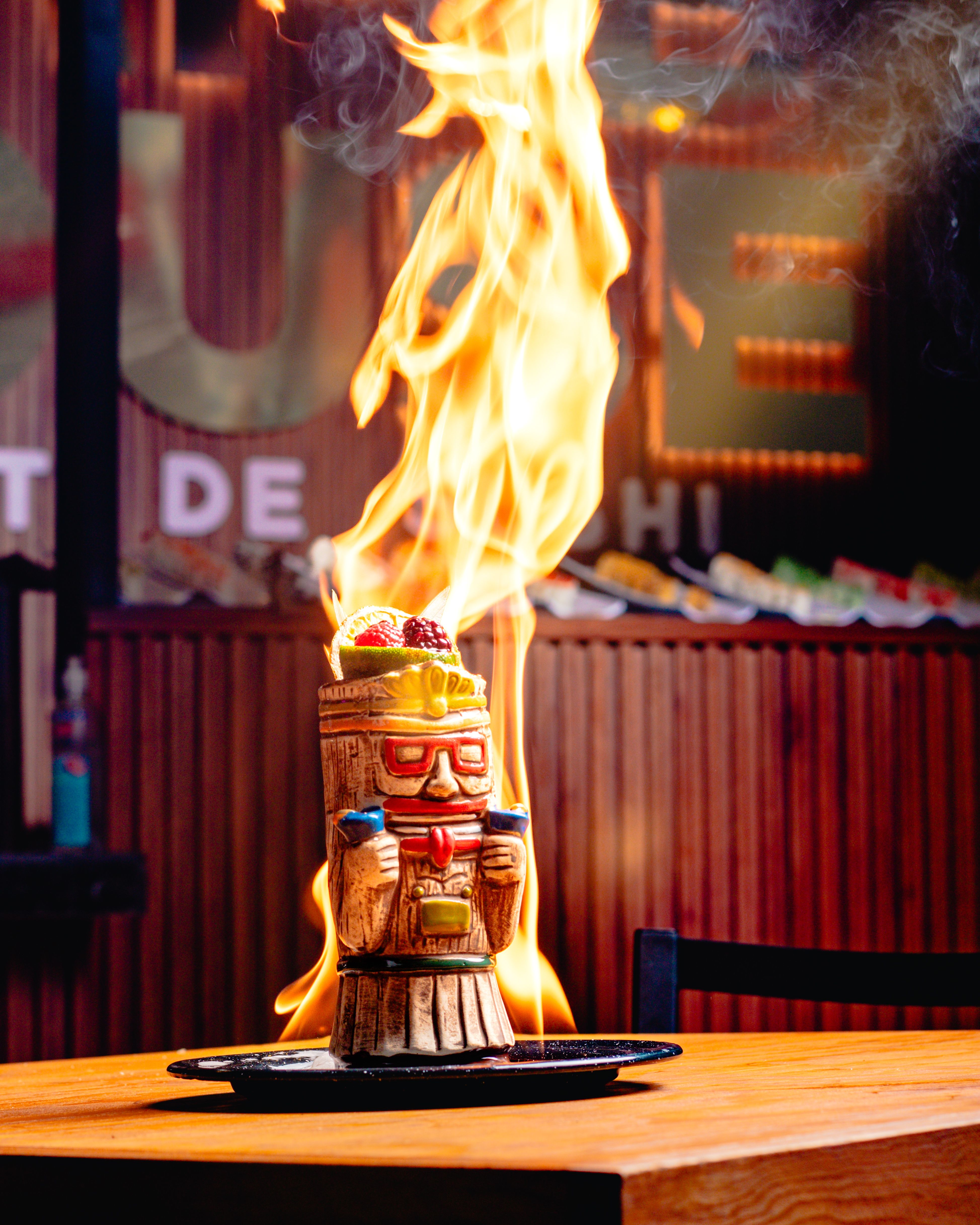 Flaming Cocktail in Tiki Mug on Restaurant Table · Free Stock Photo