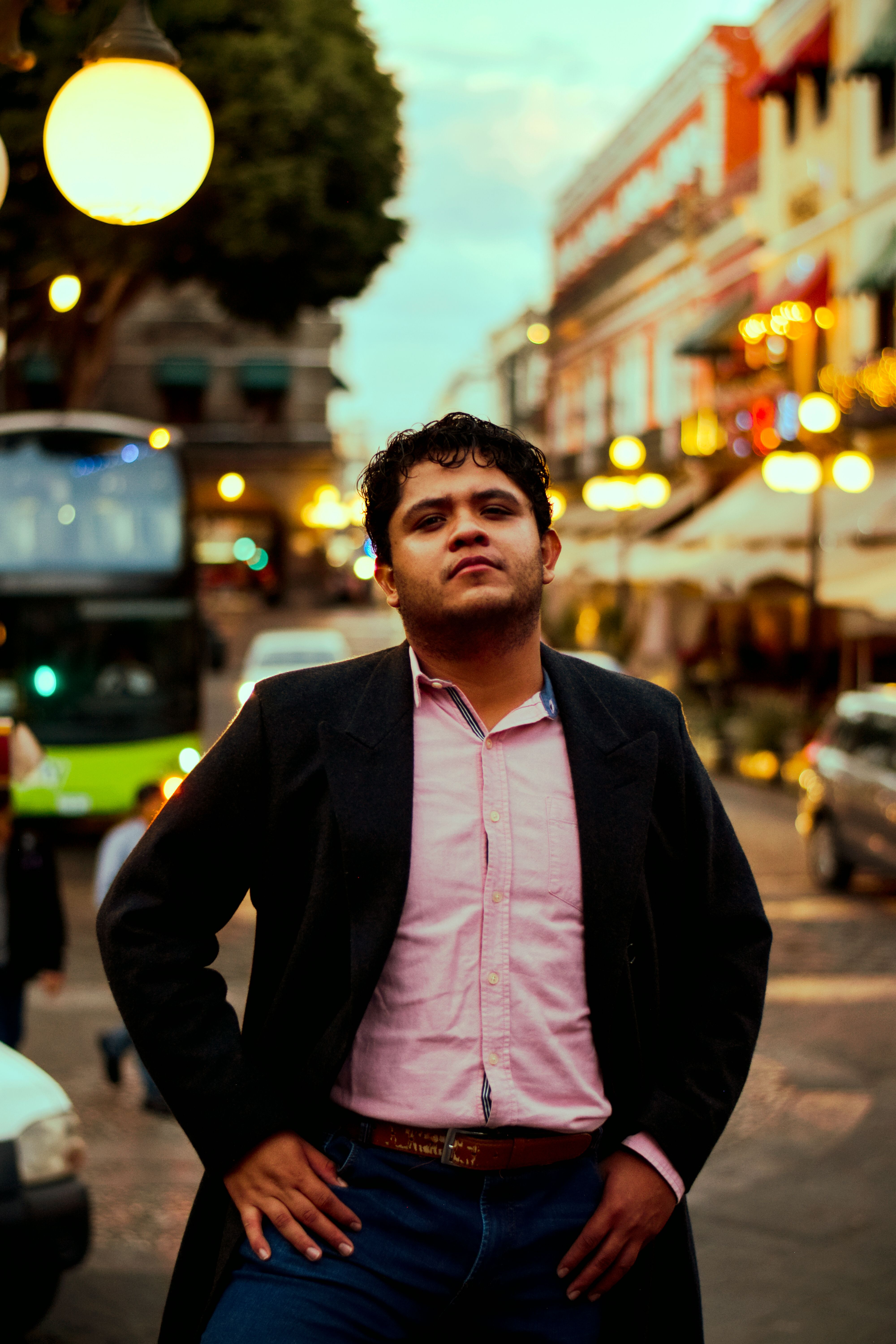 Confident Man Standing in Urban Setting at Dusk · Free Stock Photo