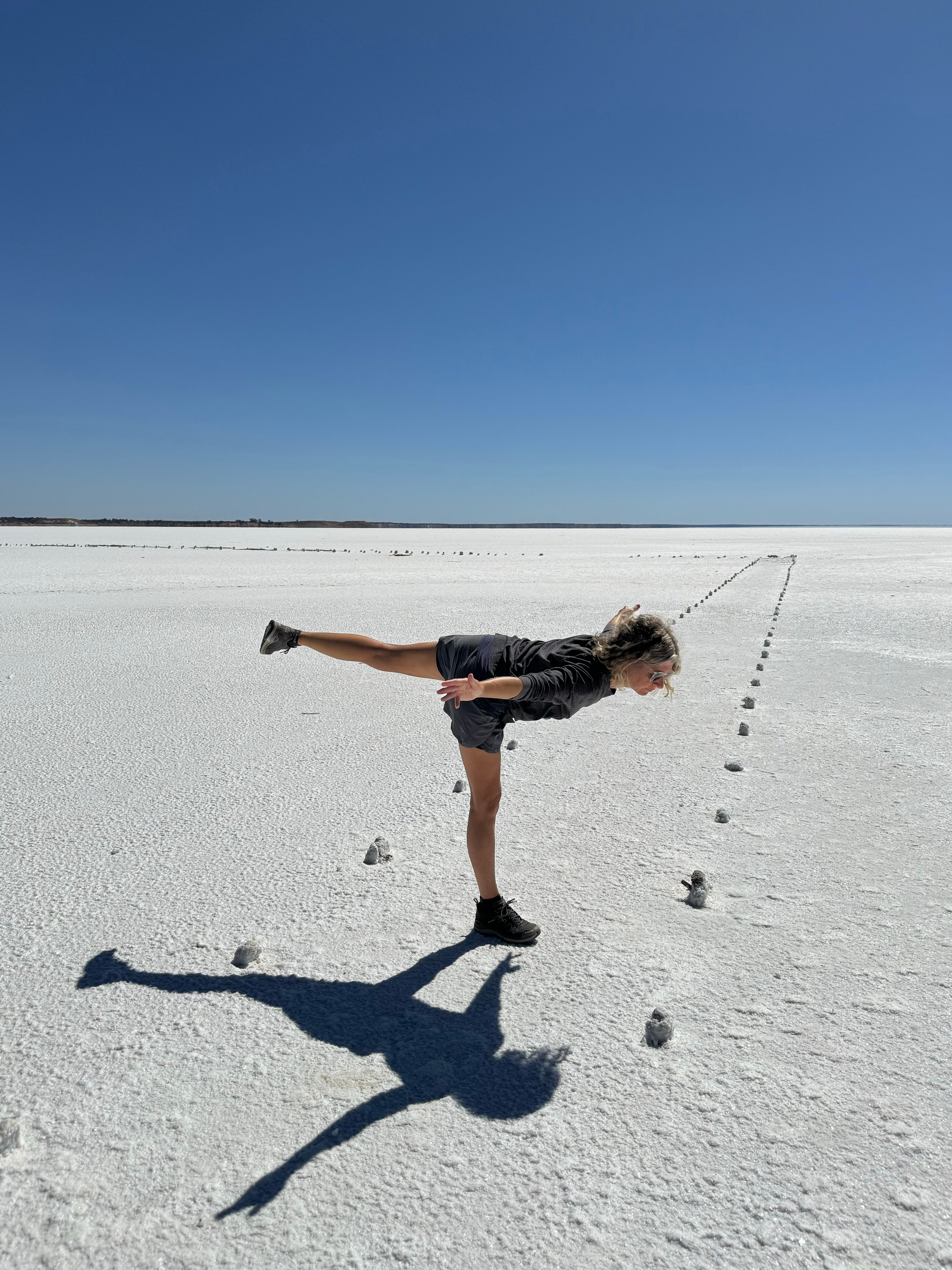 Yoga Pose in Vast Salt Flat Landscape · Free Stock Photo