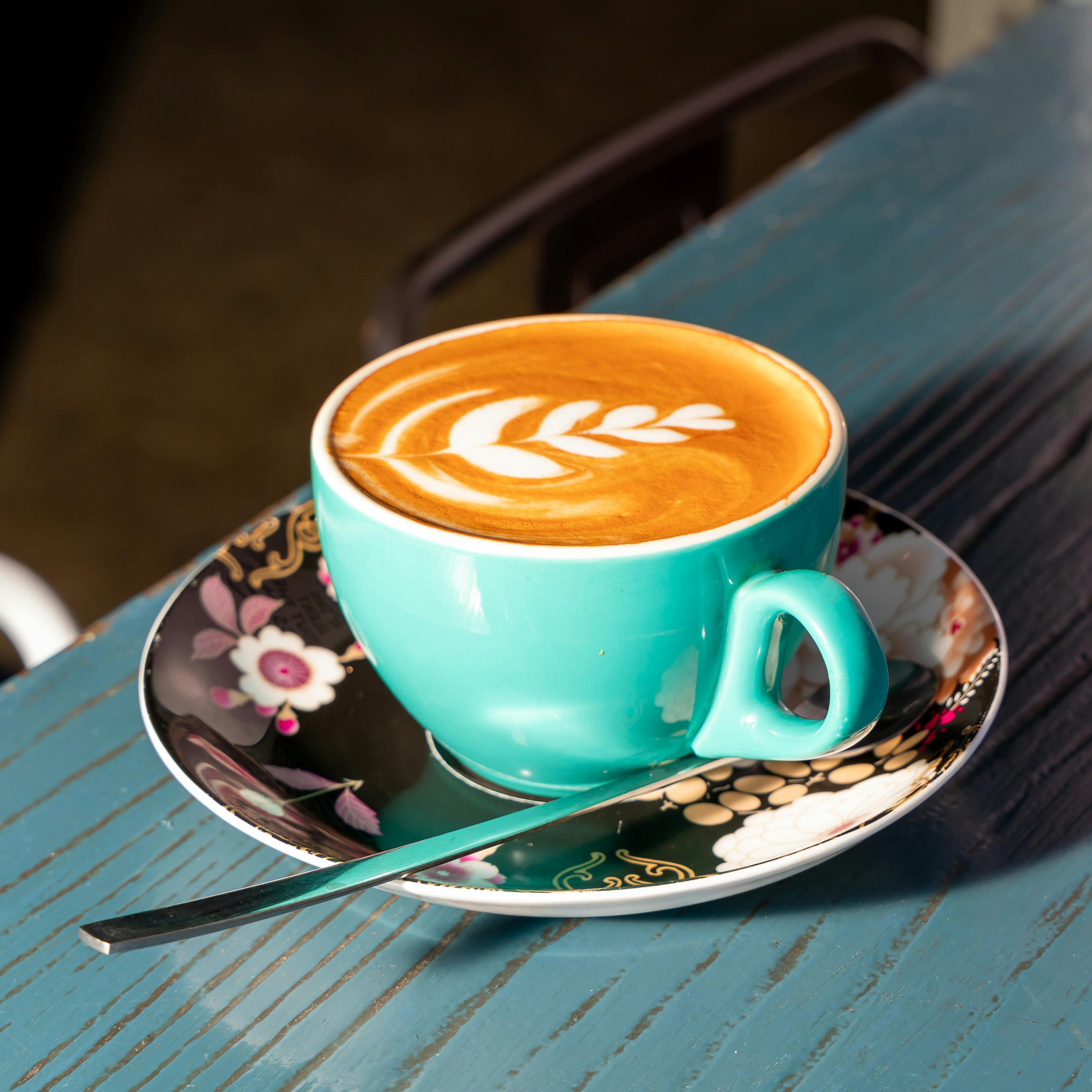 Colorful Latte Art in a Vibrant Blue Cup · Free Stock Photo