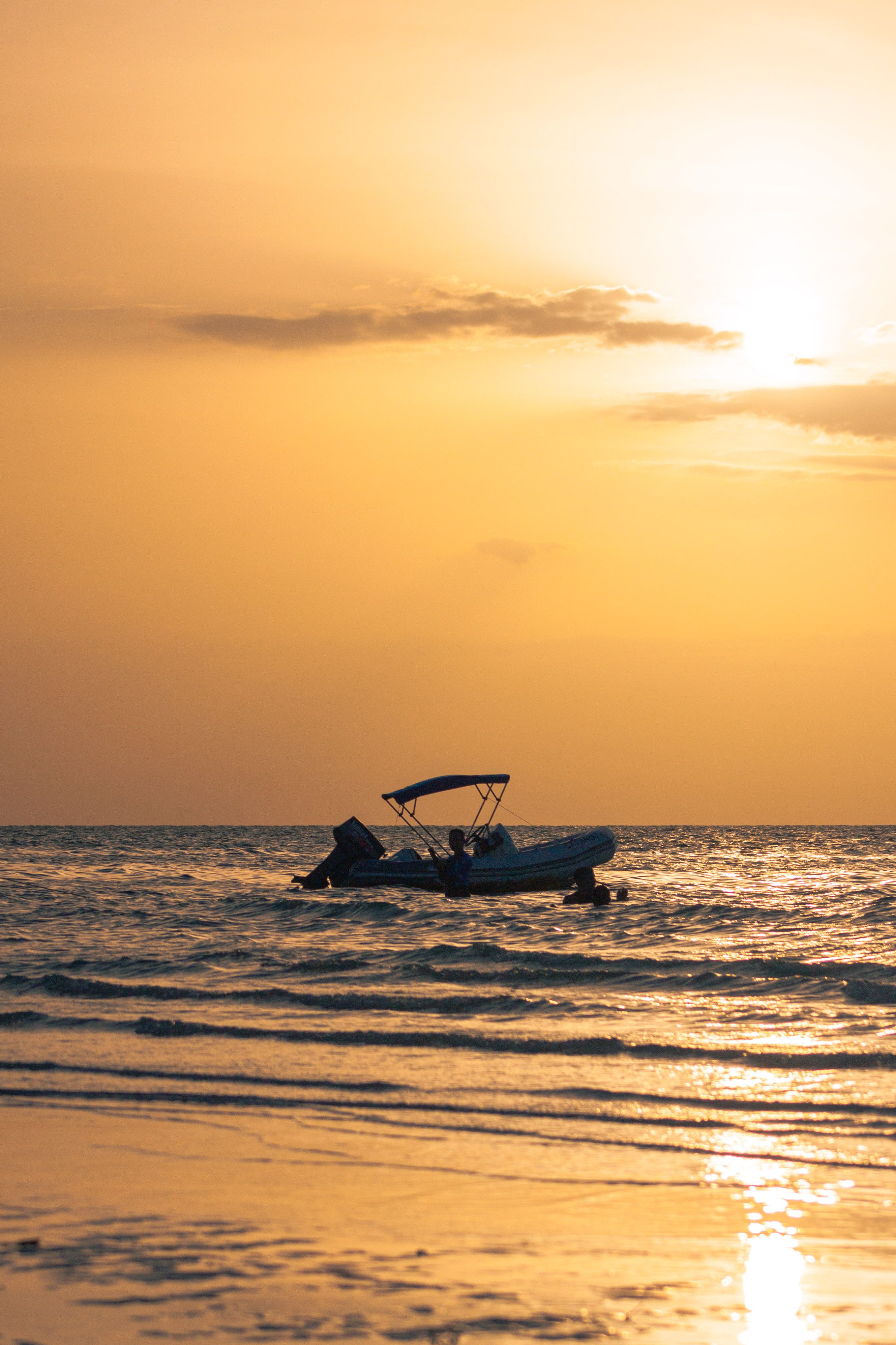 Serene Sunset Boat Ride on the Ocean · Free Stock Photo