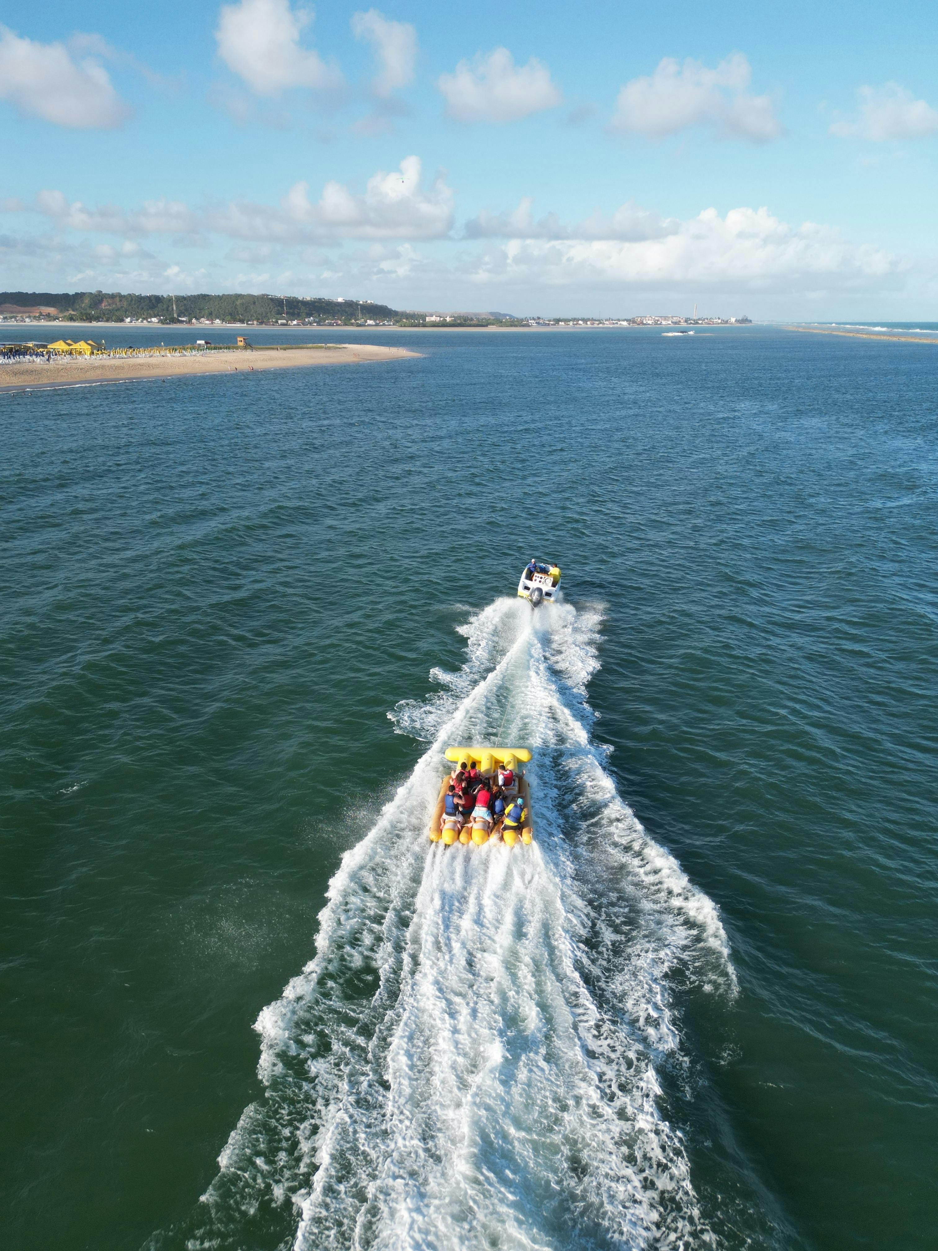 Exciting Banana Boat Ride on Blue Ocean Waters · Free Stock Photo