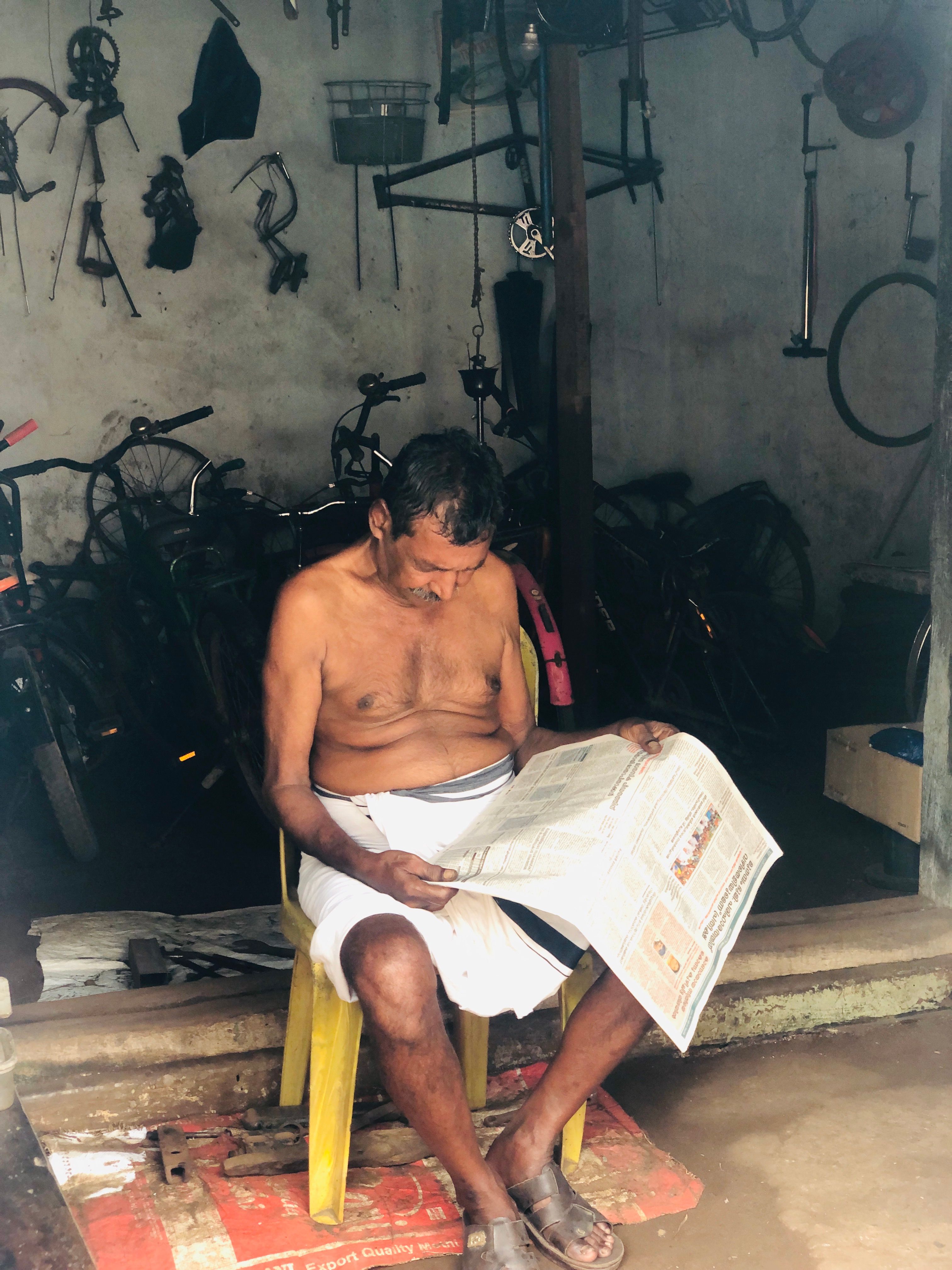 Elderly Man Reading Newspaper in Kerala Shop · Free Stock Photo