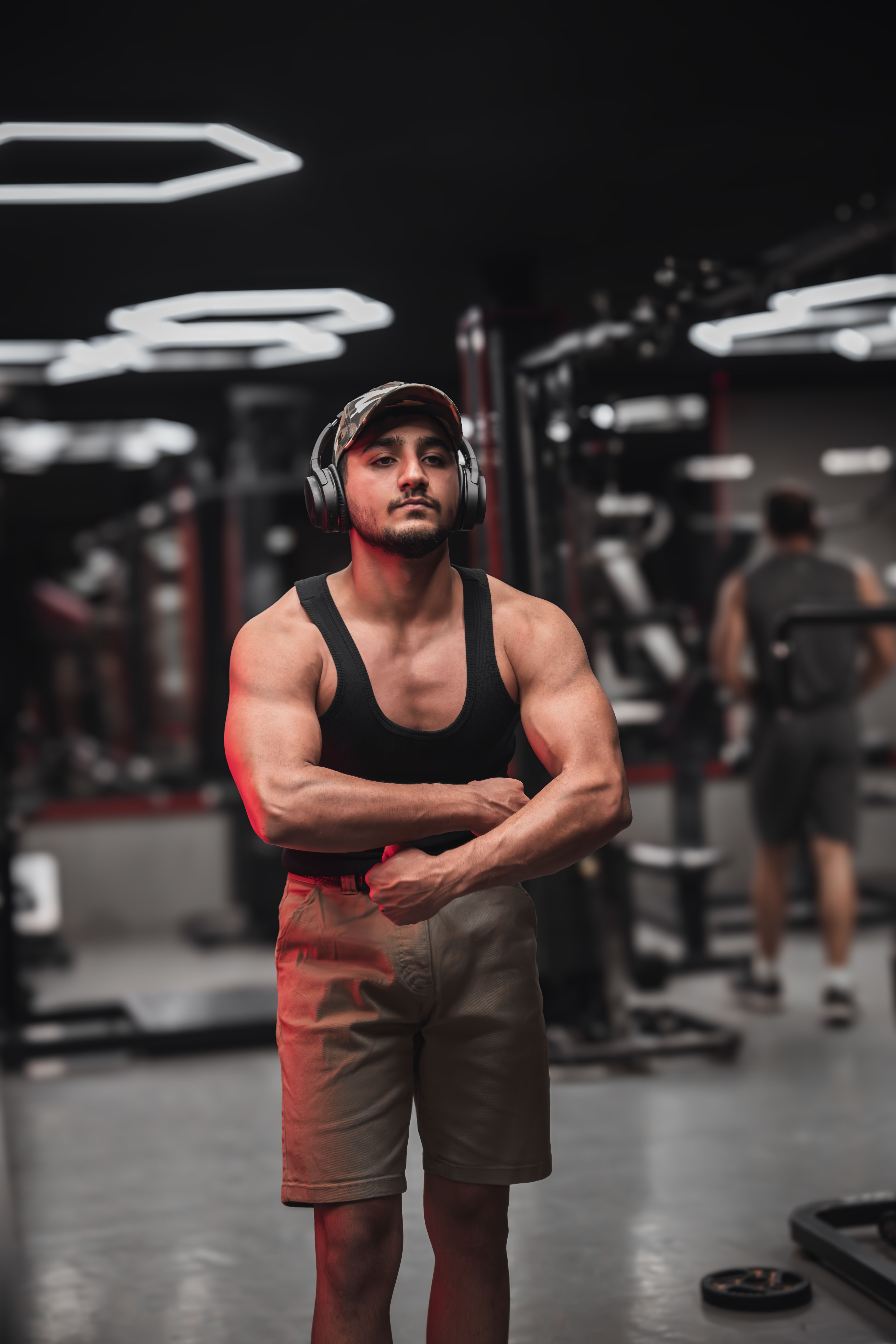 Muscular Man Posing Confidently in Gym Environment · Free Stock Photo