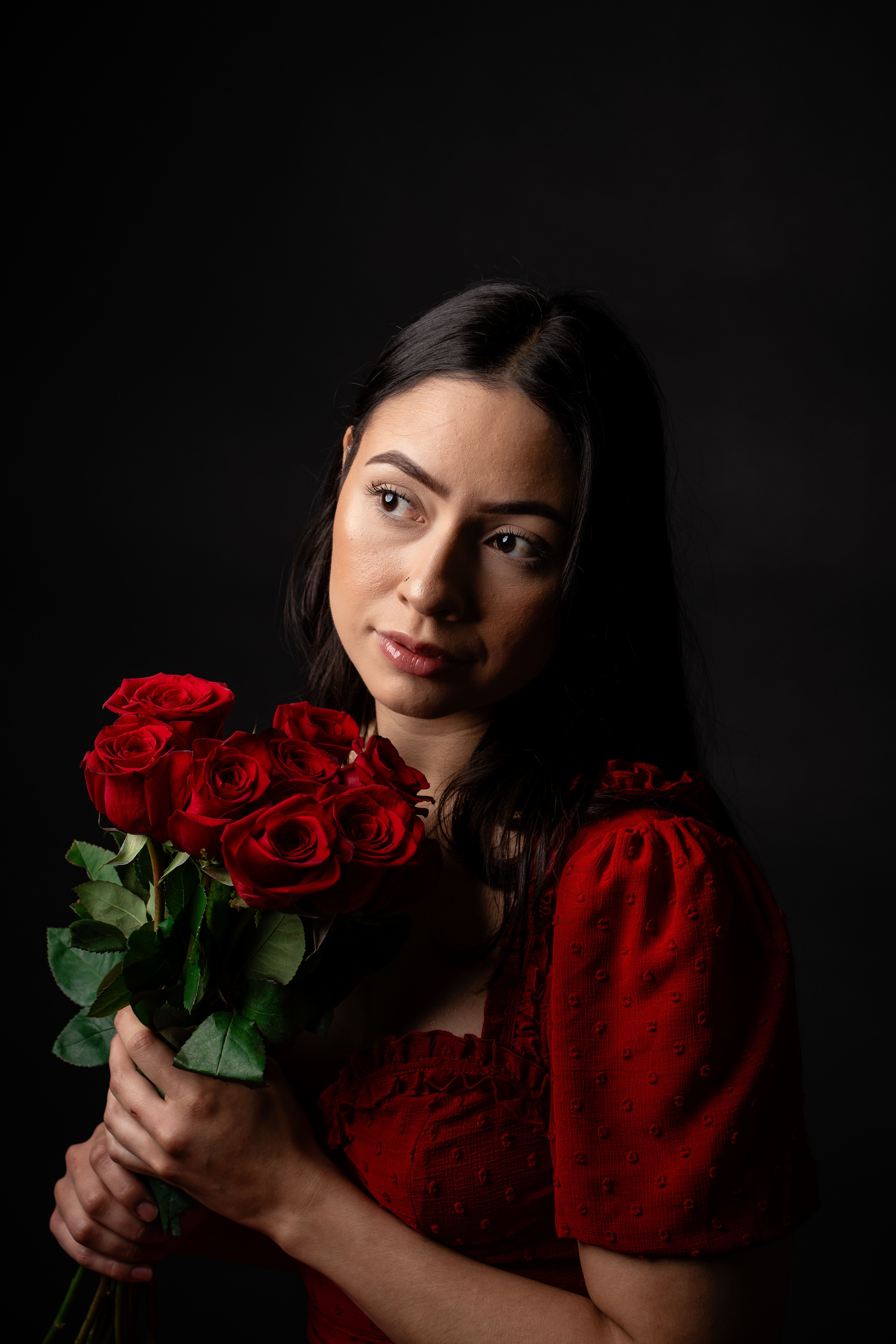 Woman Holding Red Roses in Dramatic Portrait · Free Stock Photo