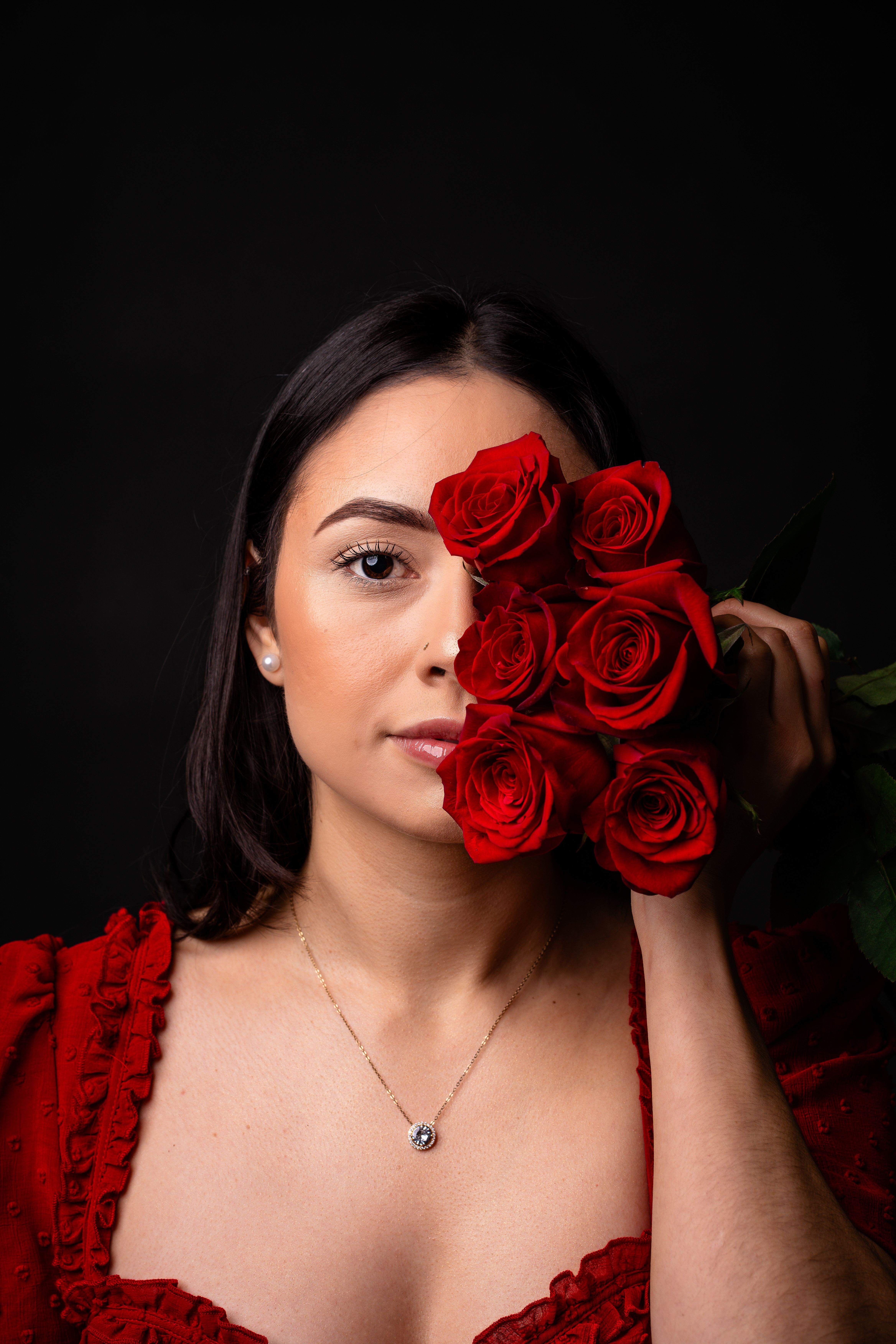 Portrait of Woman with Red Roses on Black Background · Free Stock Photo