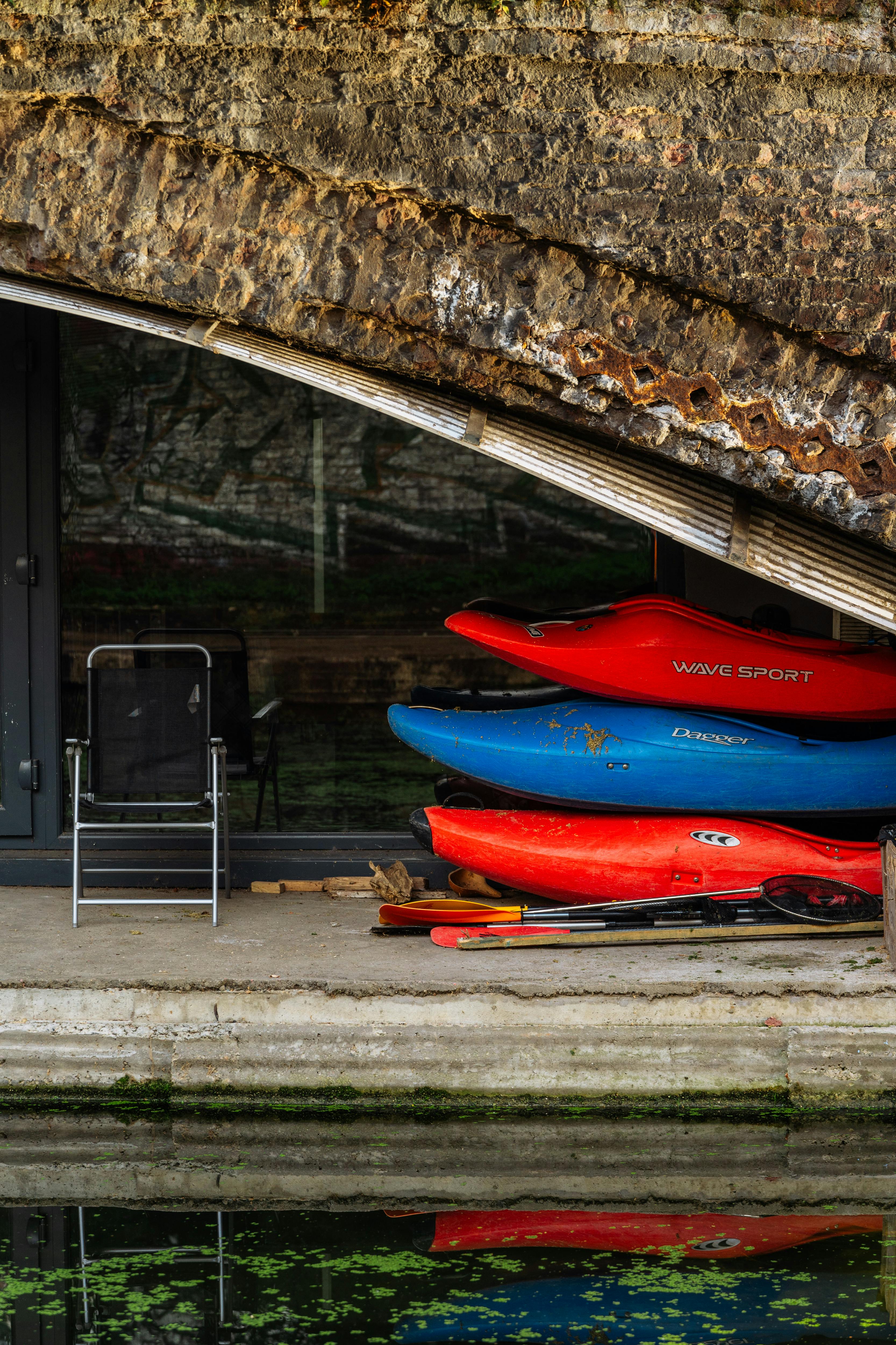 Kayaks Stored Under Rustic Bridge in London · Free Stock Photo