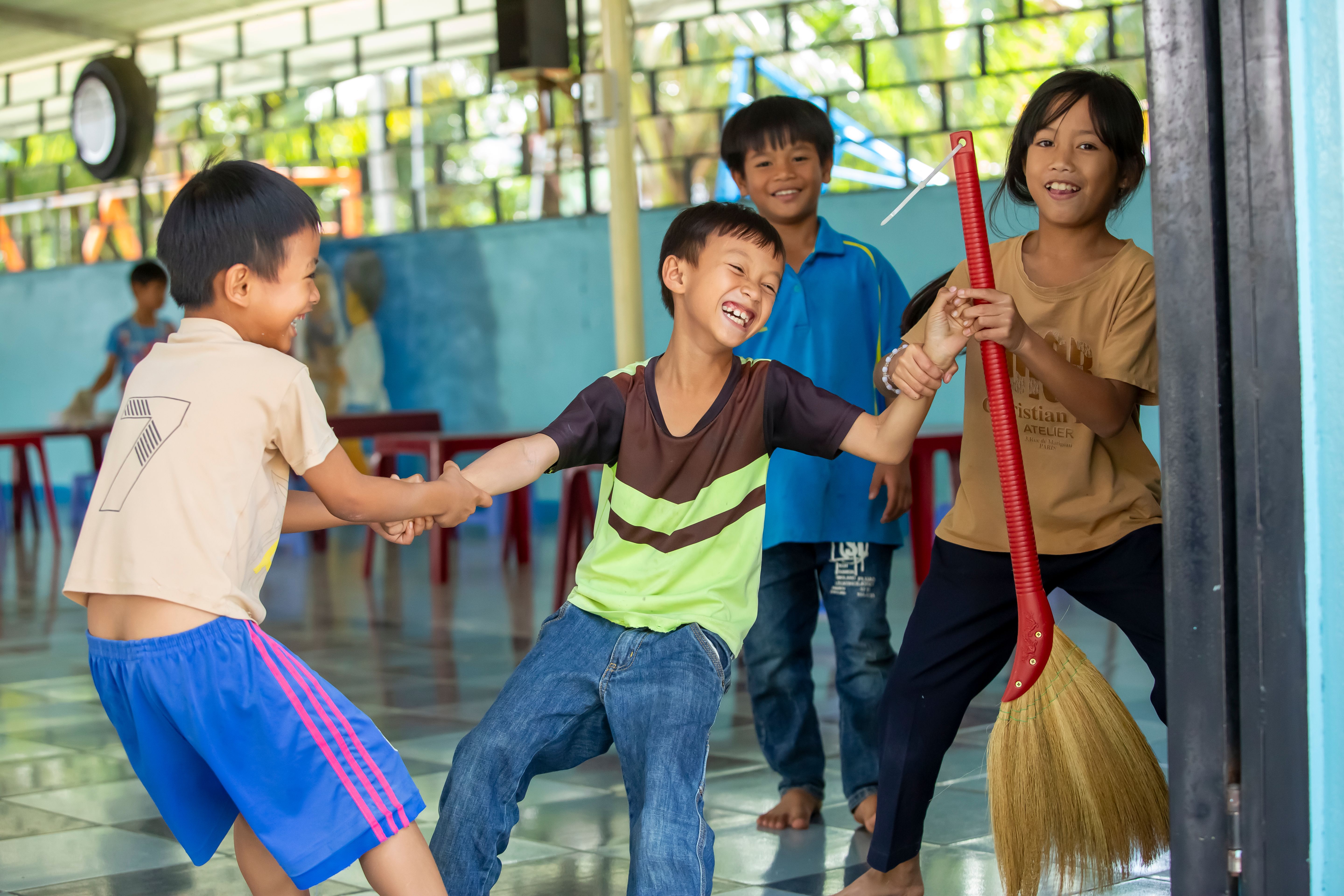 Joyful Children Playing Indoors at Shelter · Free Stock Photo