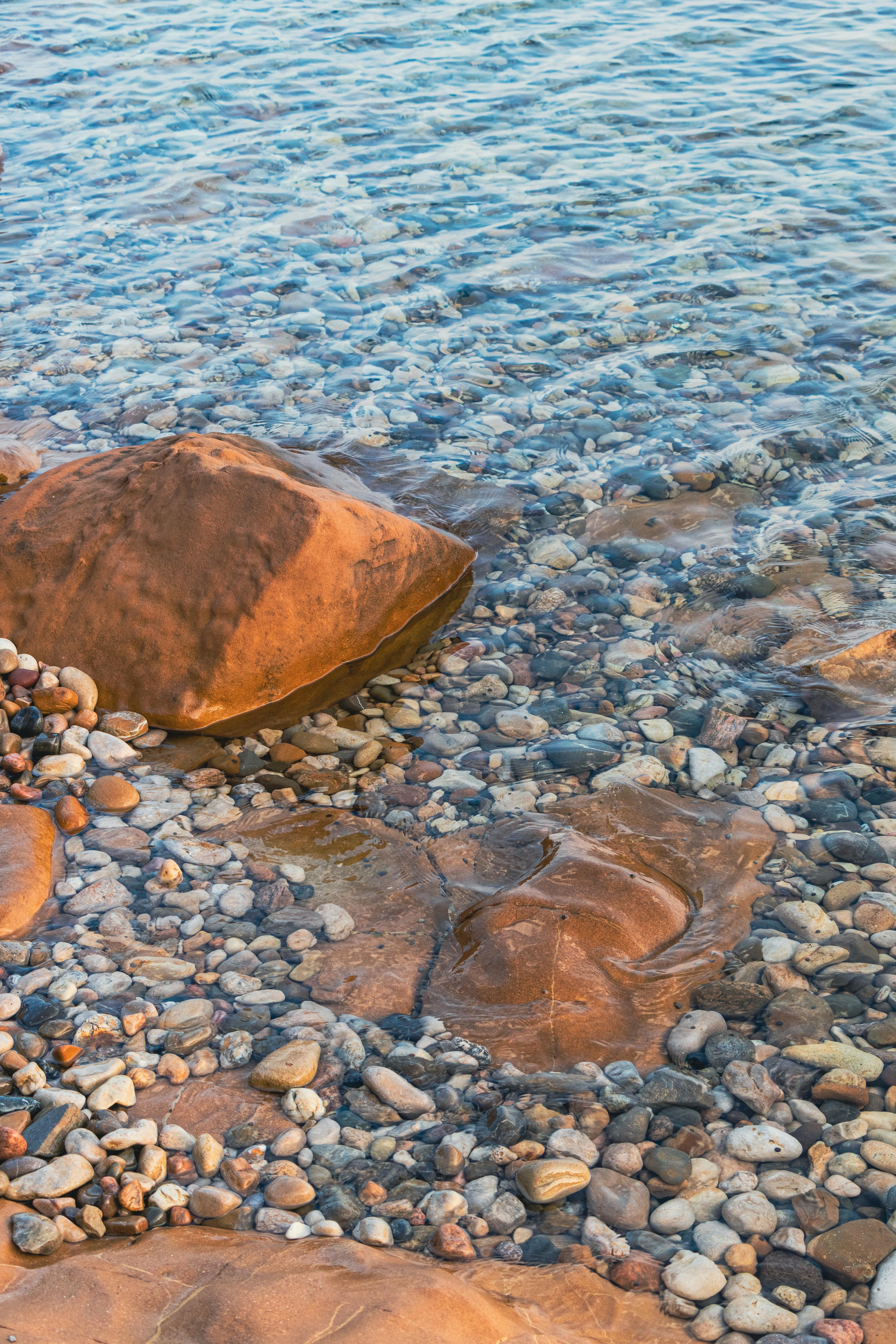 Clear Water Pebble Beach with Large Rocks · Free Stock Photo