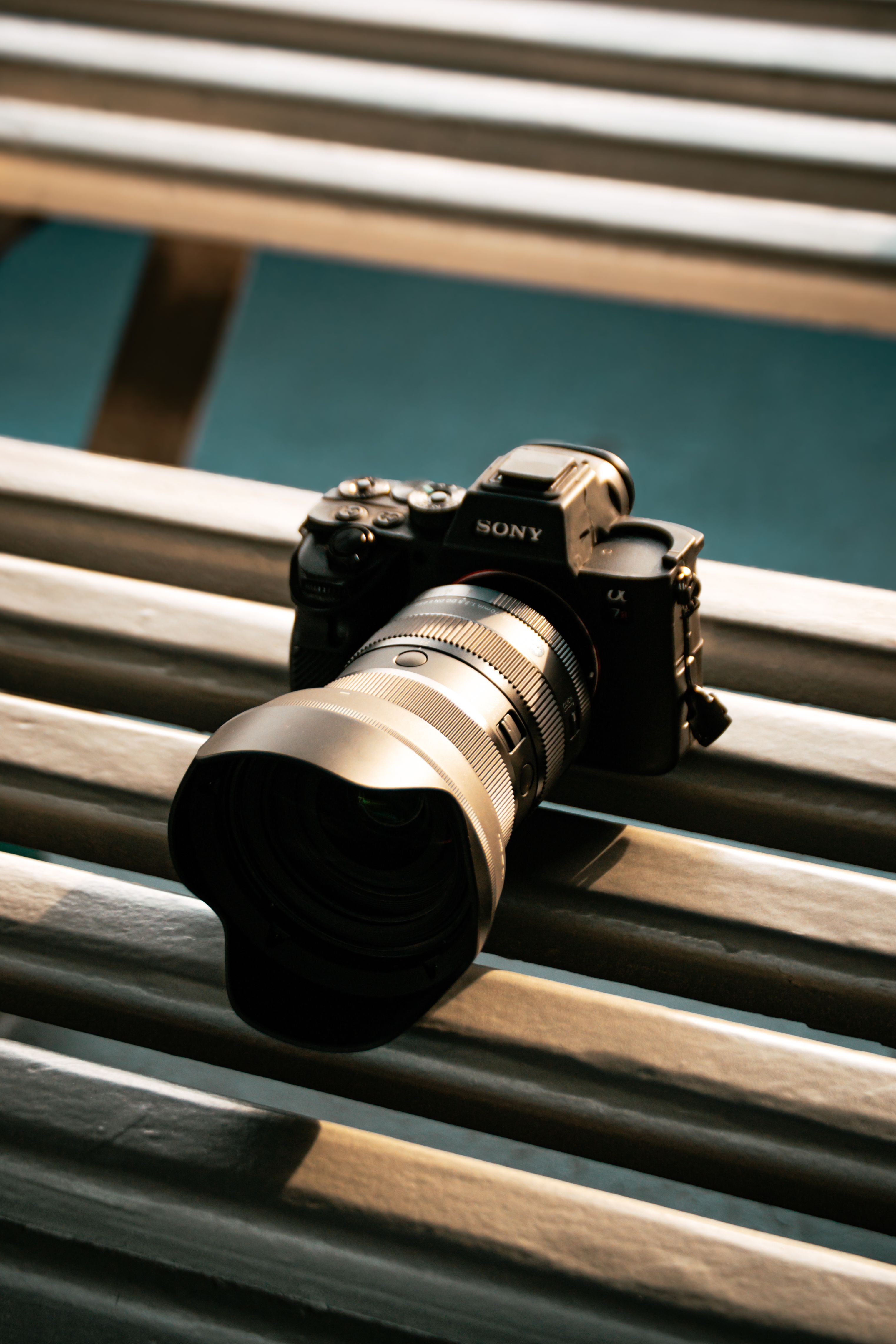 Professional Camera on Metal Surface in Sunlight · Free Stock Photo