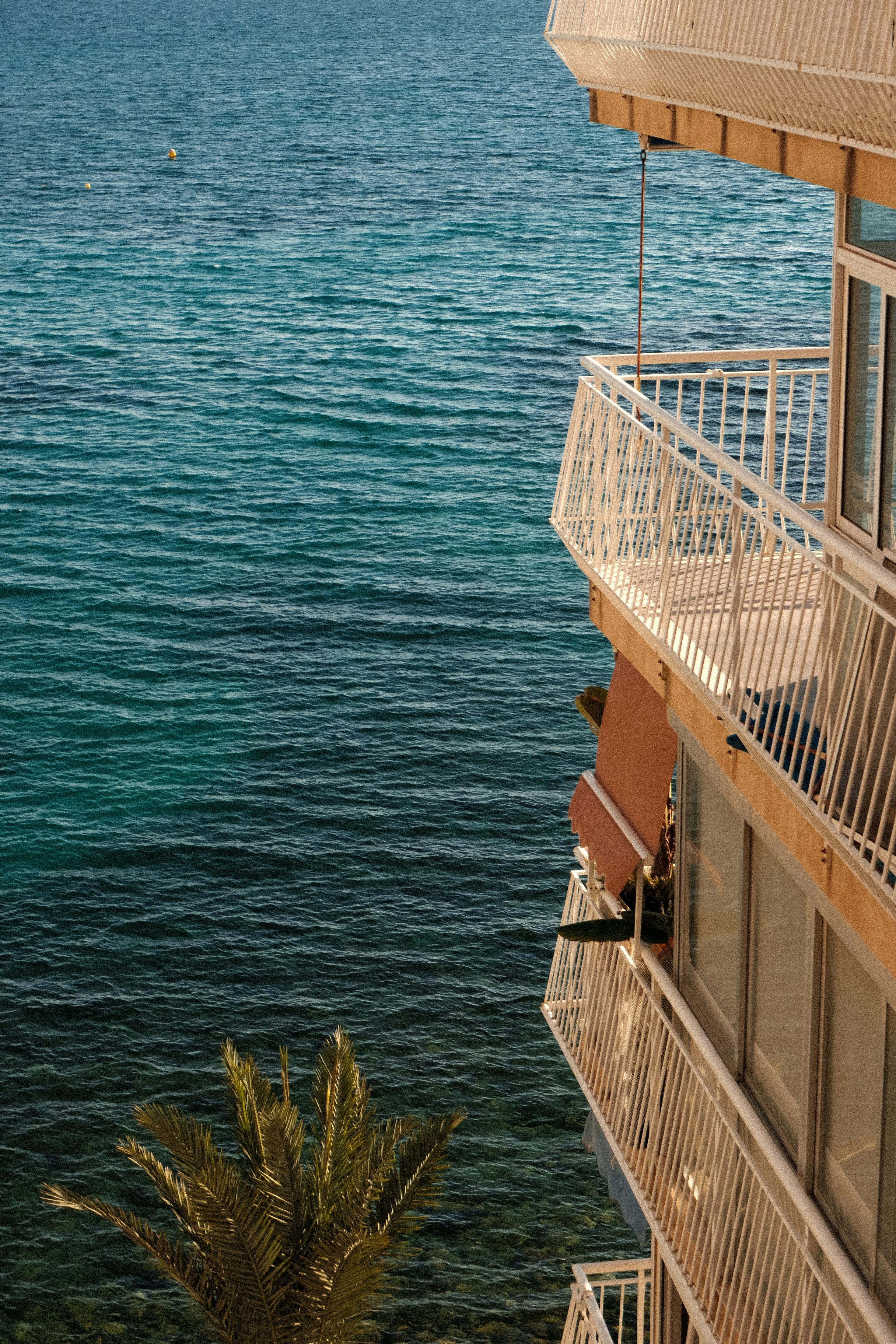 Oceanfront Balcony Overlooking Blue Sea · Free Stock Photo