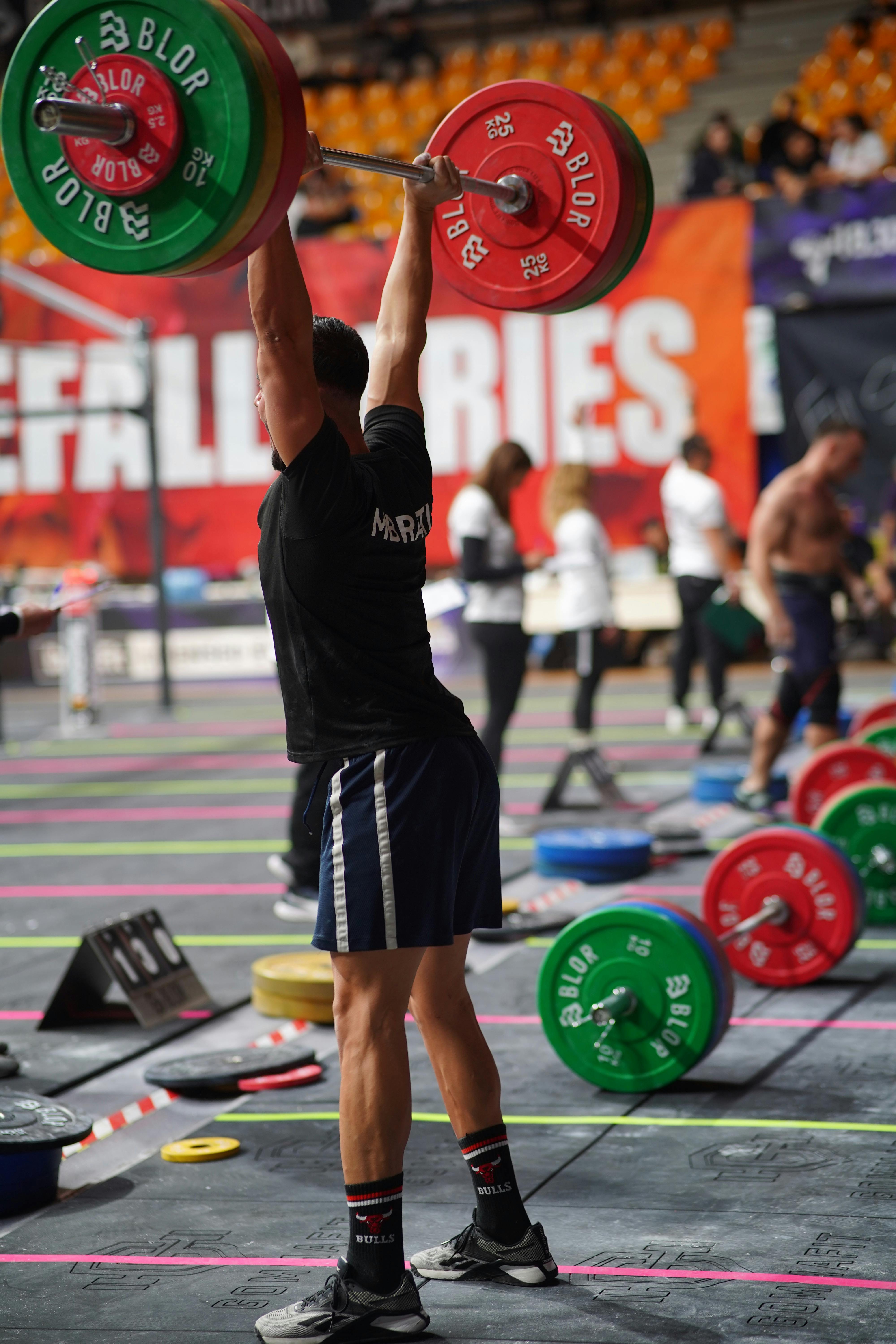 Athlete lifting weights at competitive event · Free Stock Photo