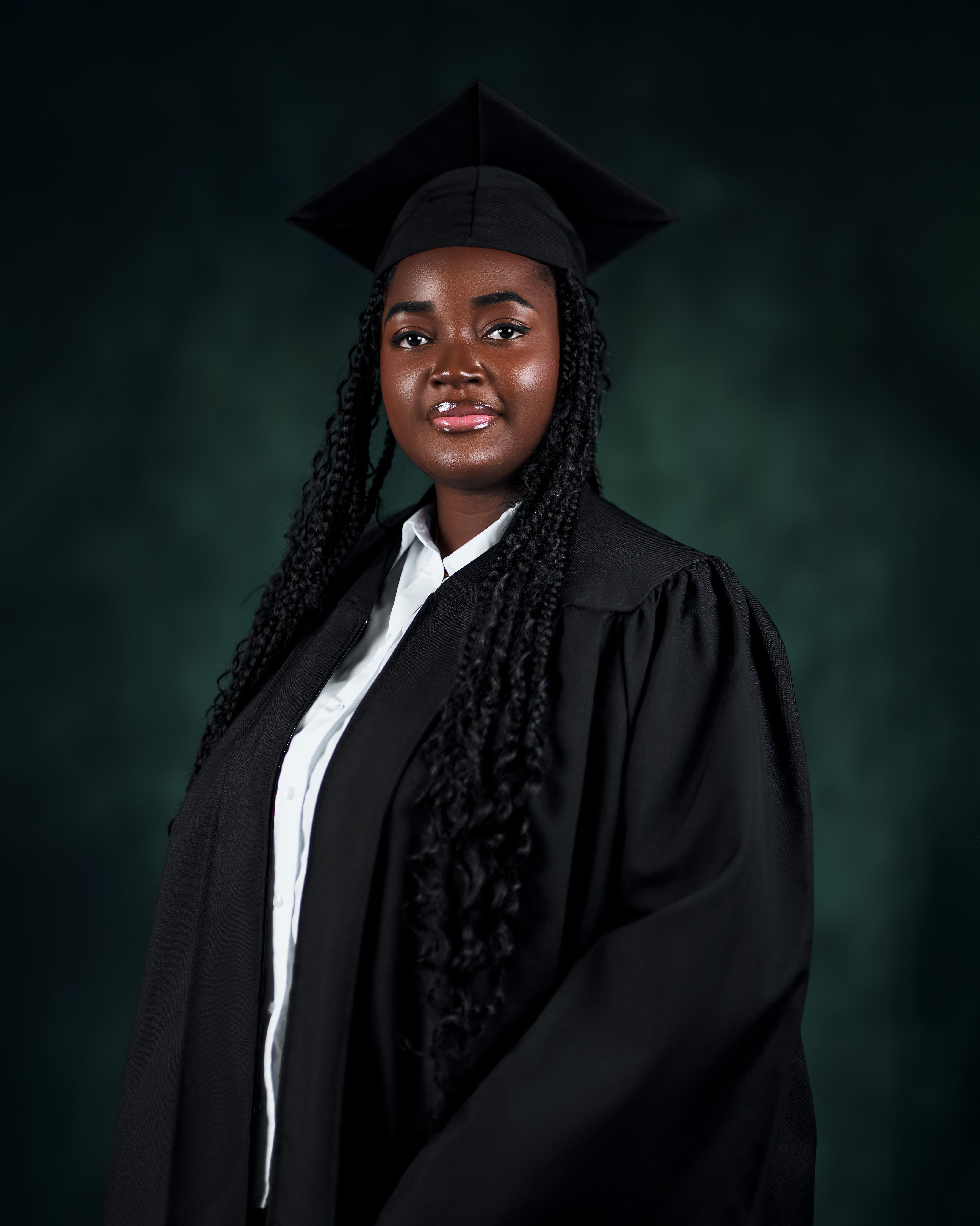 Portrait of a Female Graduate in Cap and Gown · Free Stock Photo