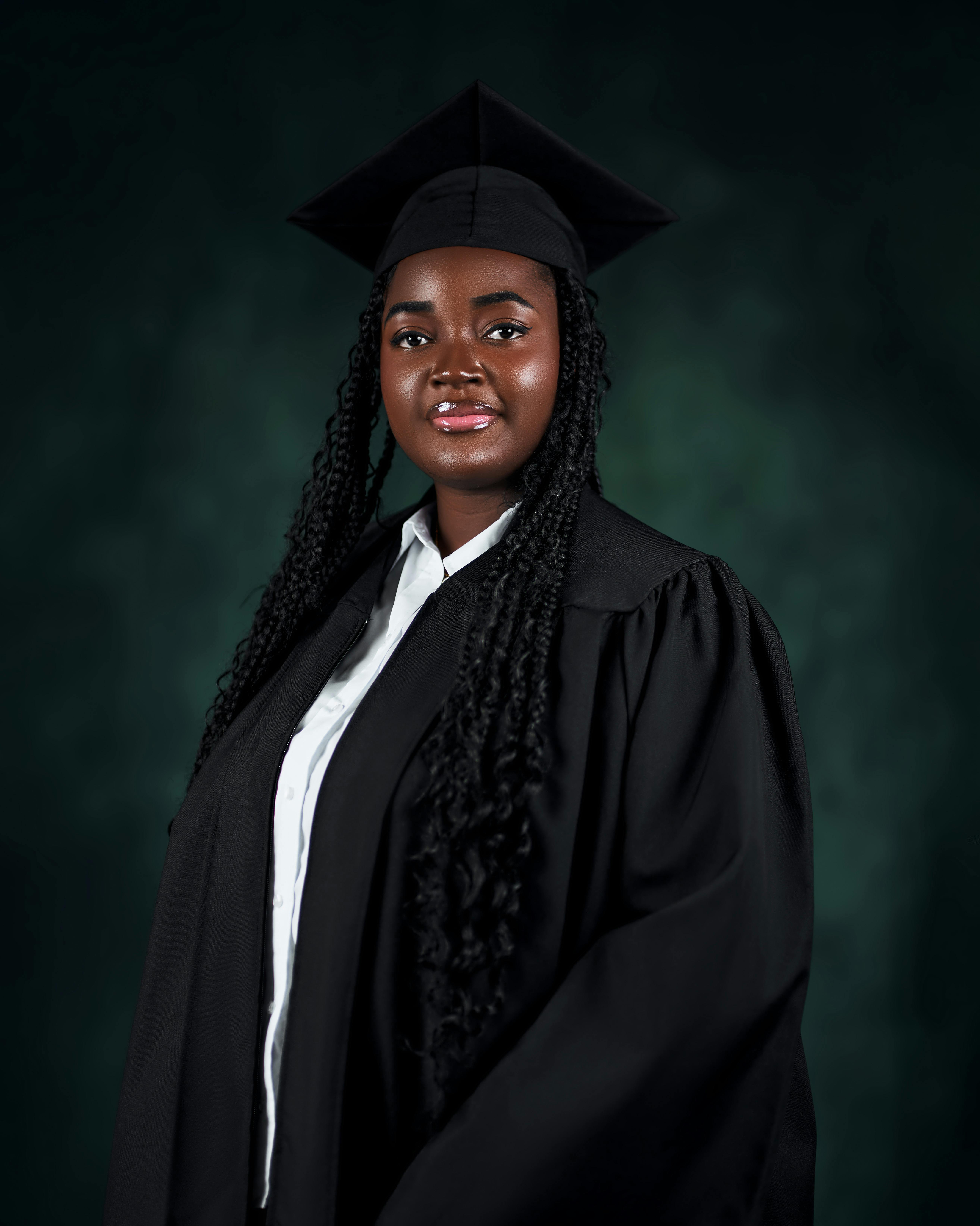 Portrait of a Female Graduate in Cap and Gown · Free Stock Photo