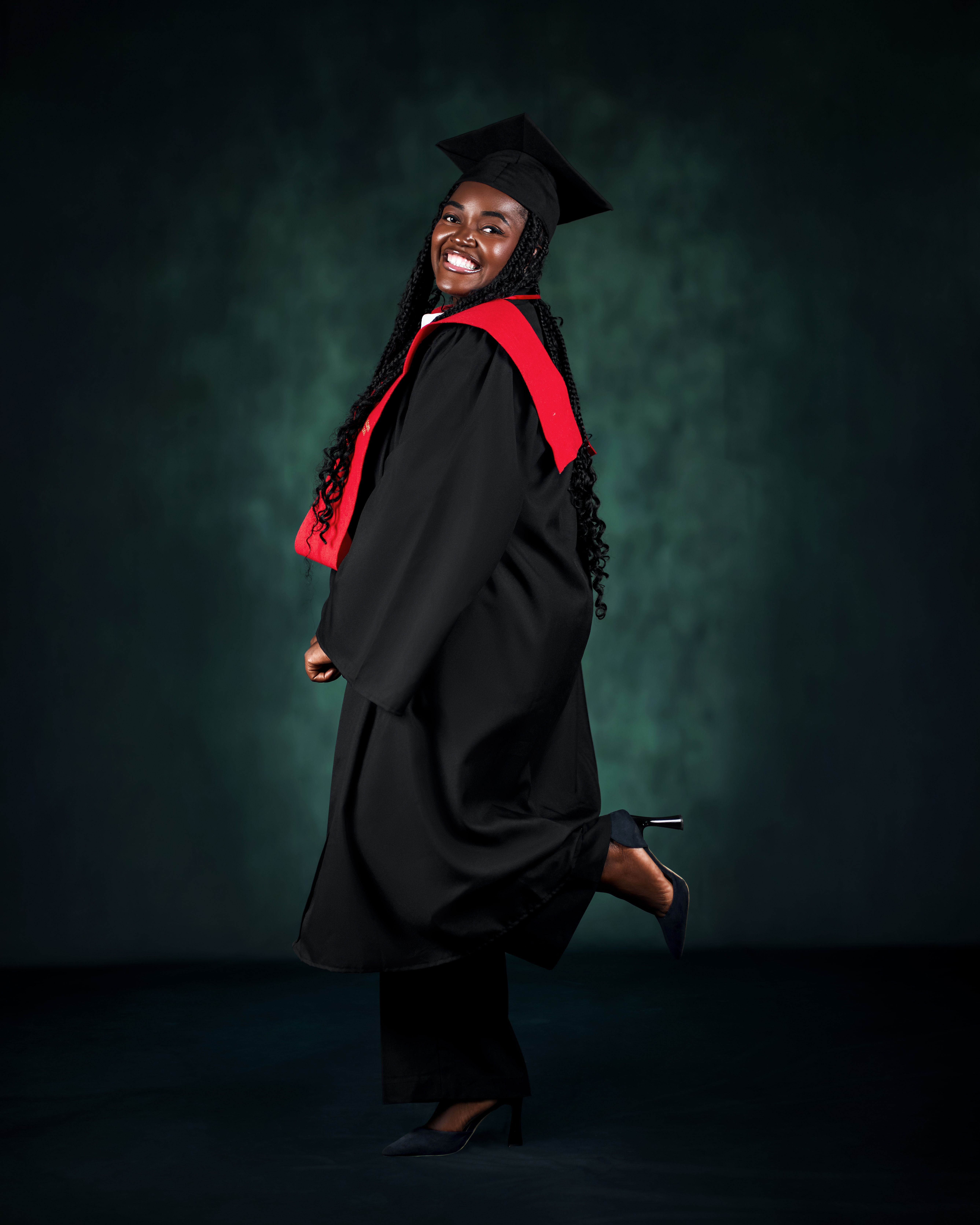 Joyful Graduate Posing in Cap and Gown · Free Stock Photo