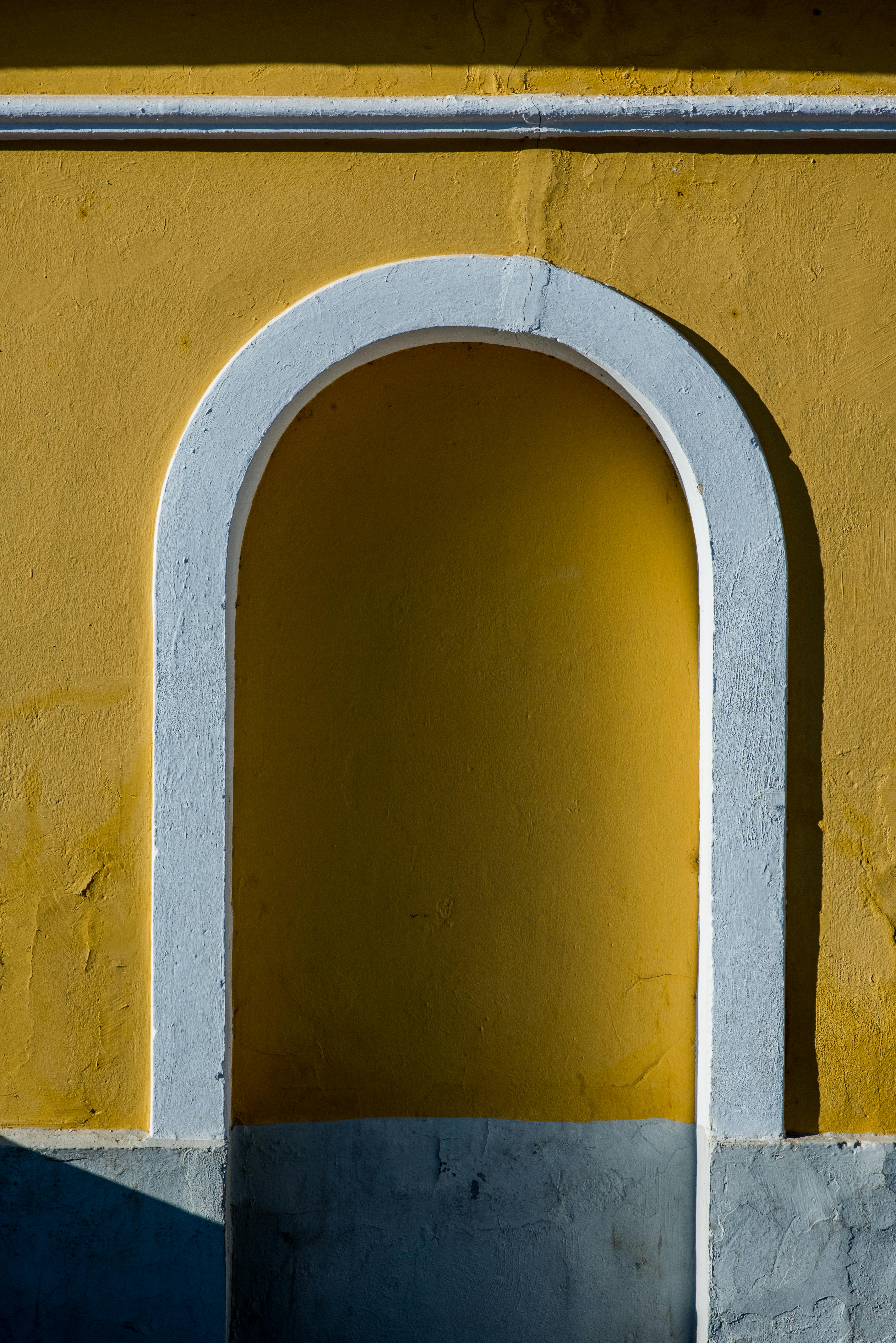 Arched Yellow Wall with Shadow Play · Free Stock Photo