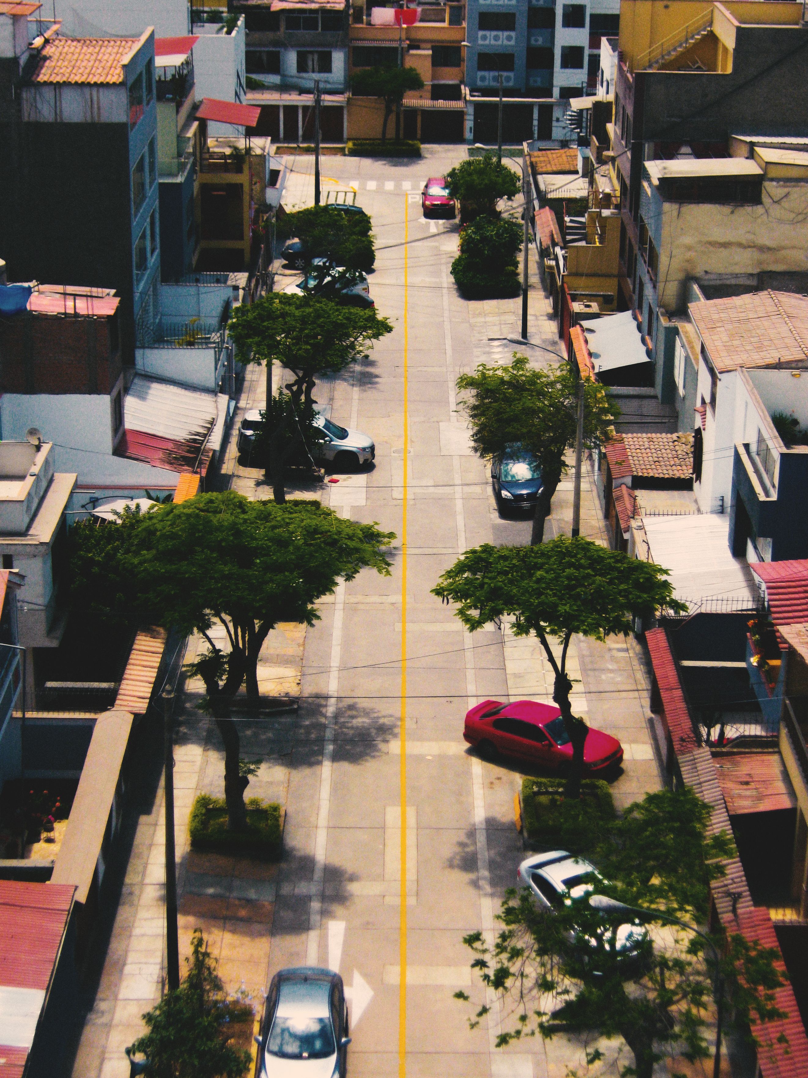 Aerial View of Urban Street with Parked Cars and Trees · Free Stock Photo