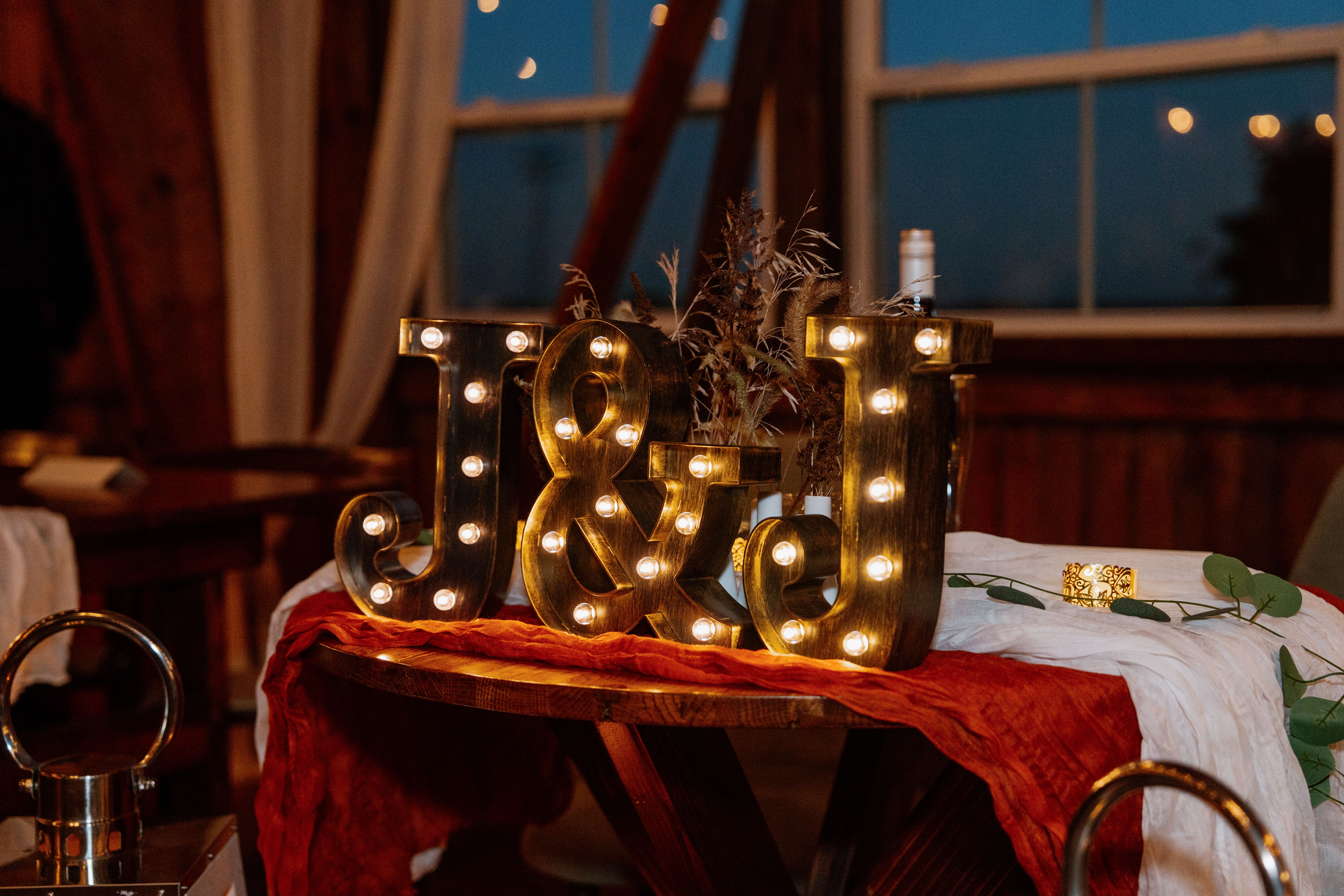 Romantic Evening Wedding Decor with Illuminated Signs · Free Stock Photo