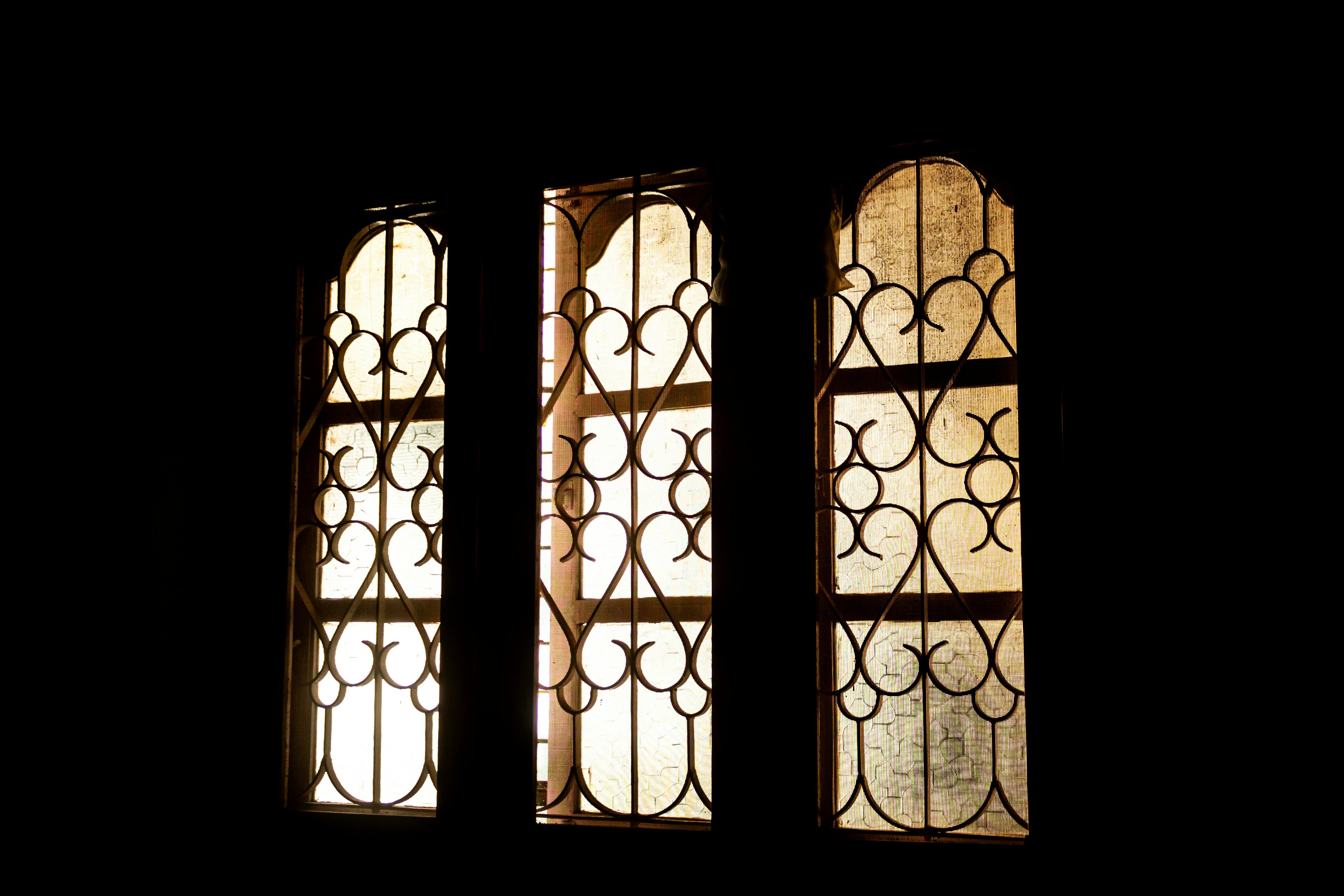 Ornate Ironwork Window with Soft Light · Free Stock Photo