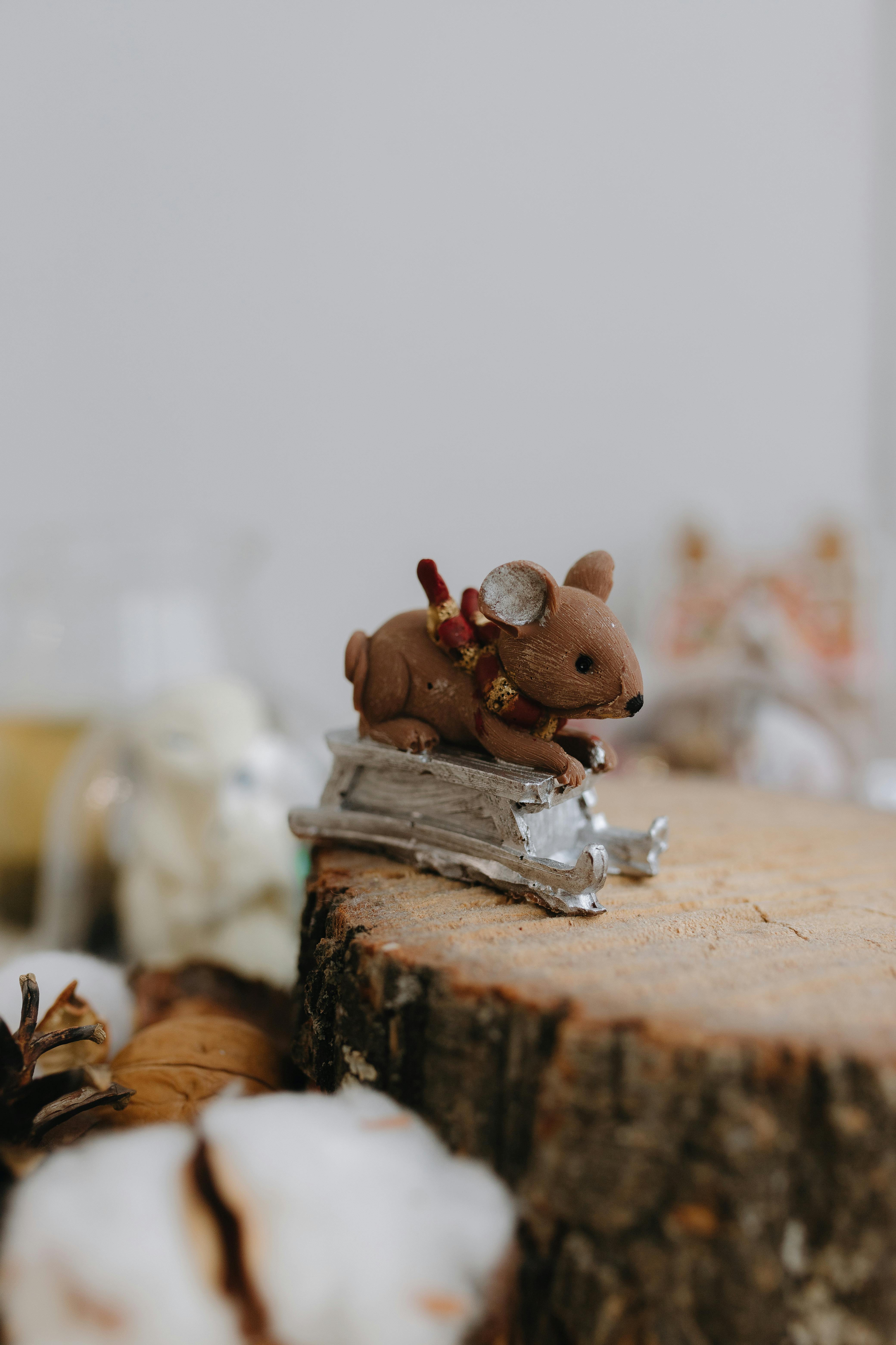 Festive Mouse Figurine on Rustic Tree Stump · Free Stock Photo