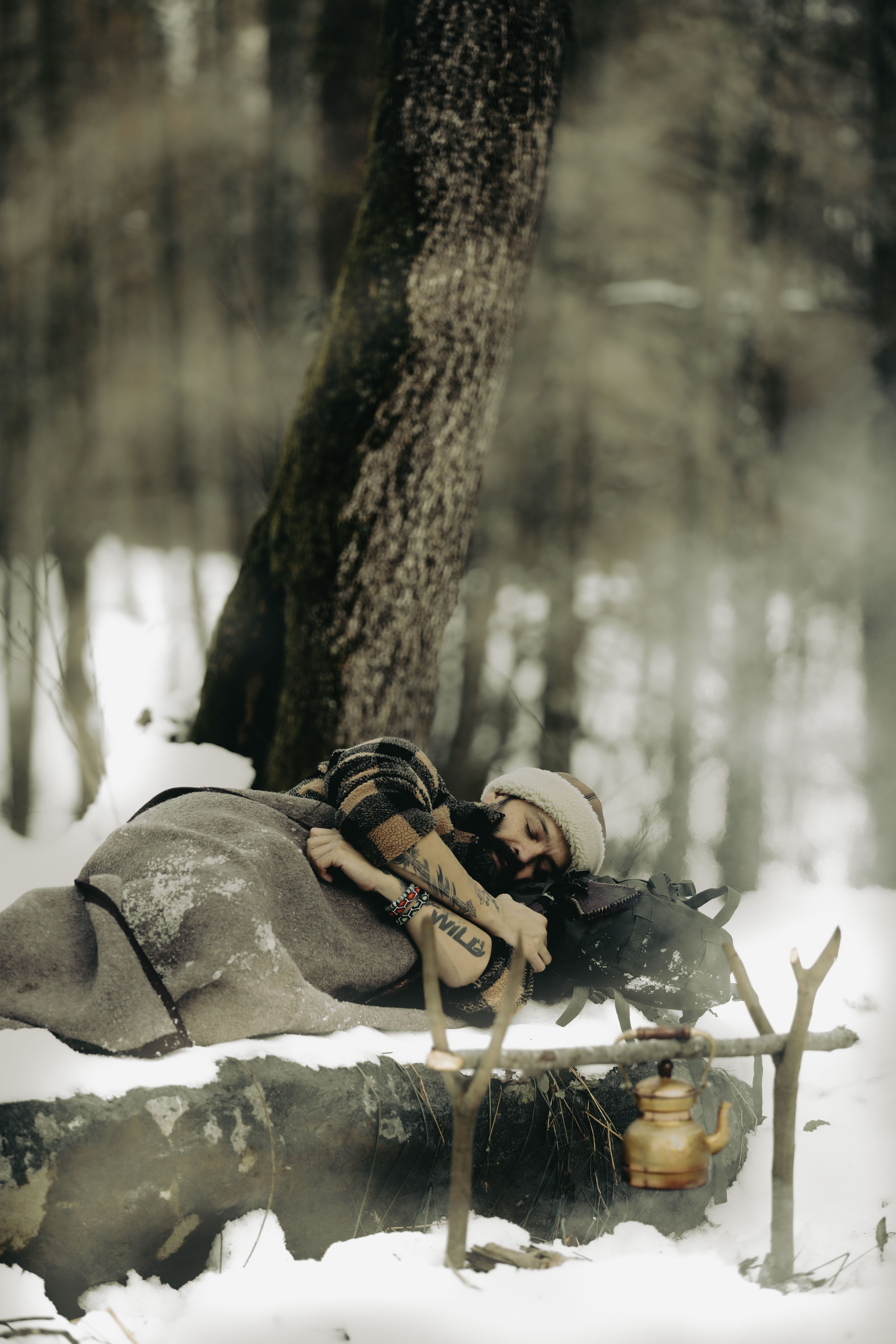 Man Sleeping in Winter Forest with Campfire · Free Stock Photo