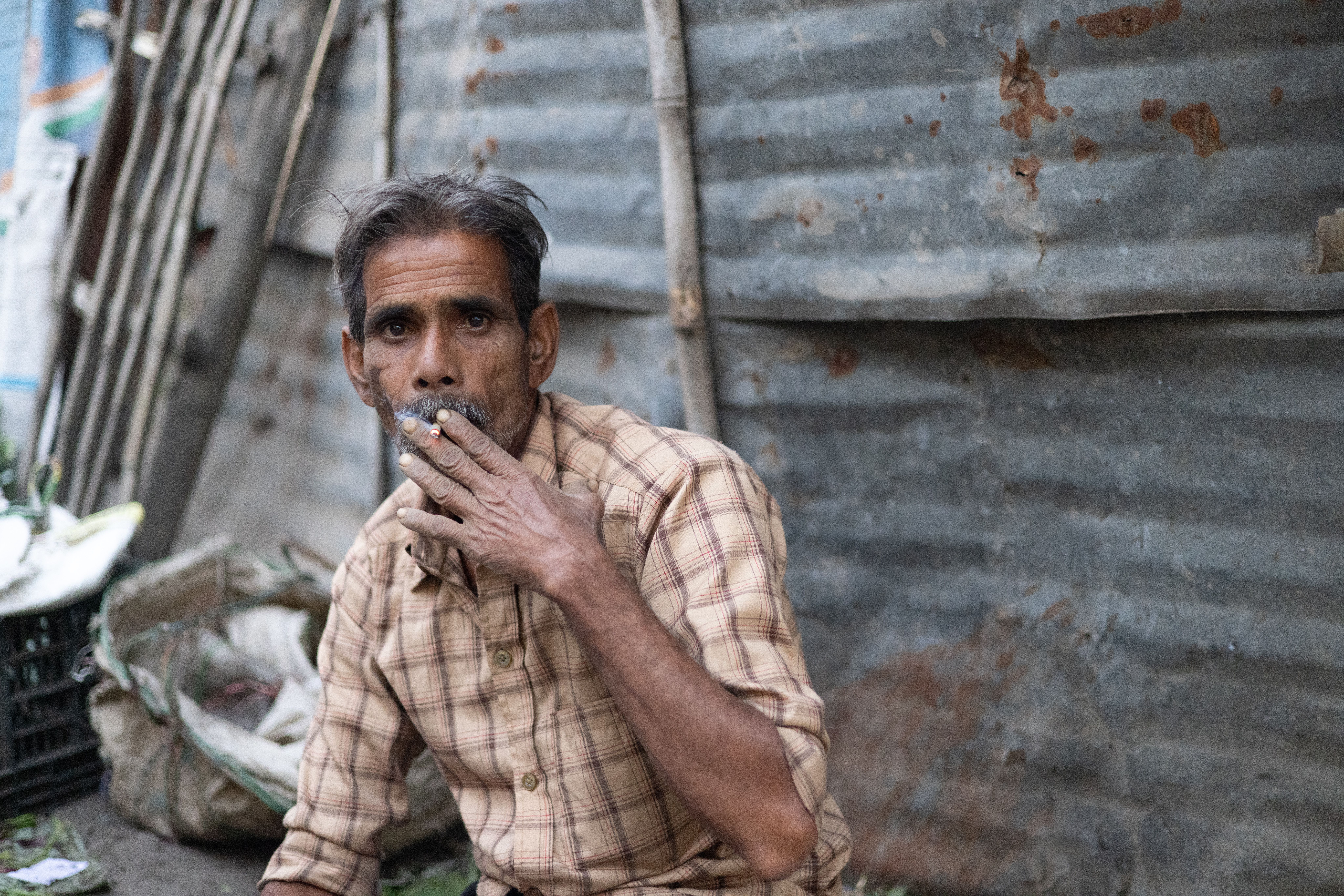 Portrait of a Man Smoking Outdoors in Urban Setting · Free Stock Photo