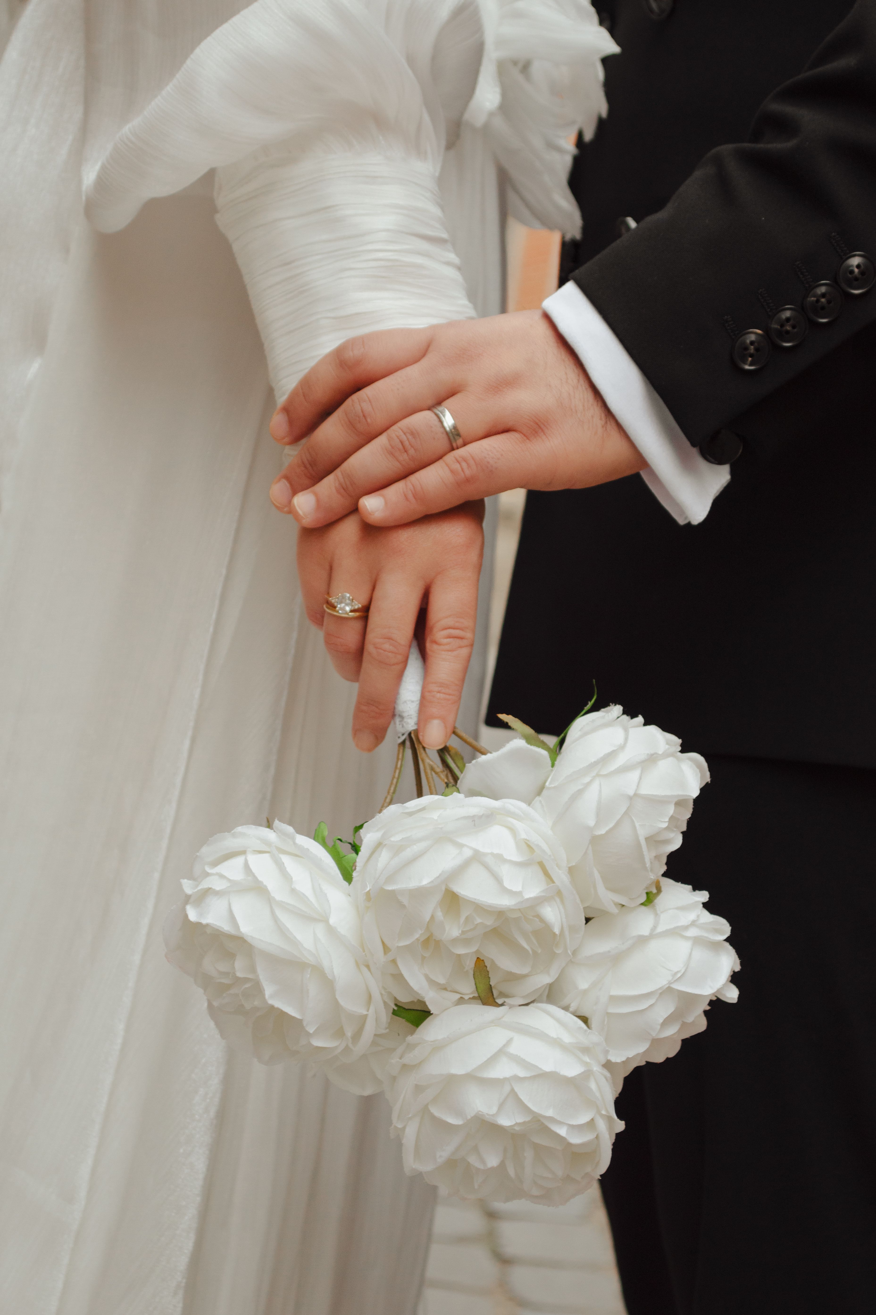 Elegant Wedding Couple Holding Bouquets Closeup · Free Stock Photo