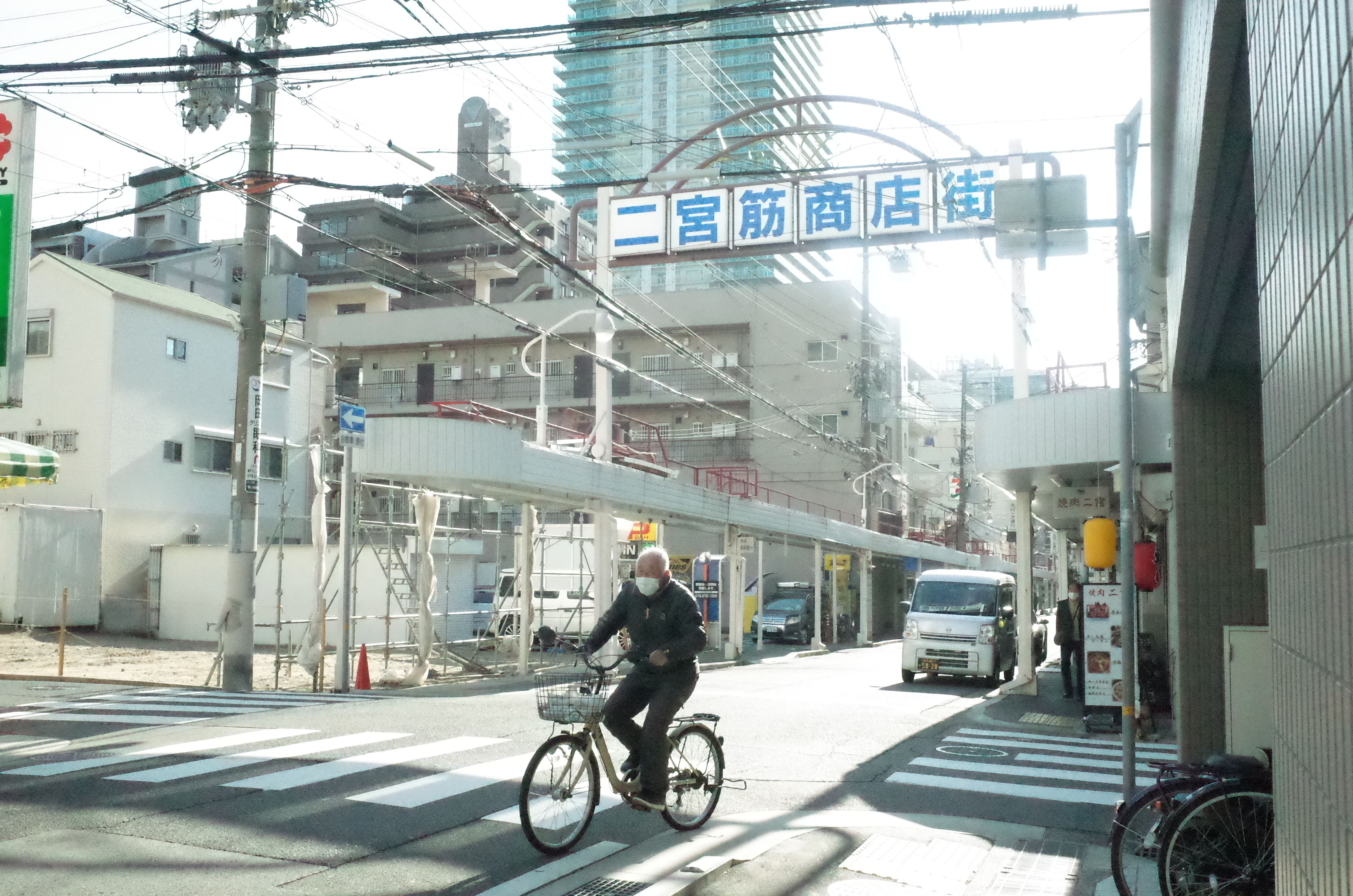 Cyclist in Urban Japanese Street Scene · Free Stock Photo