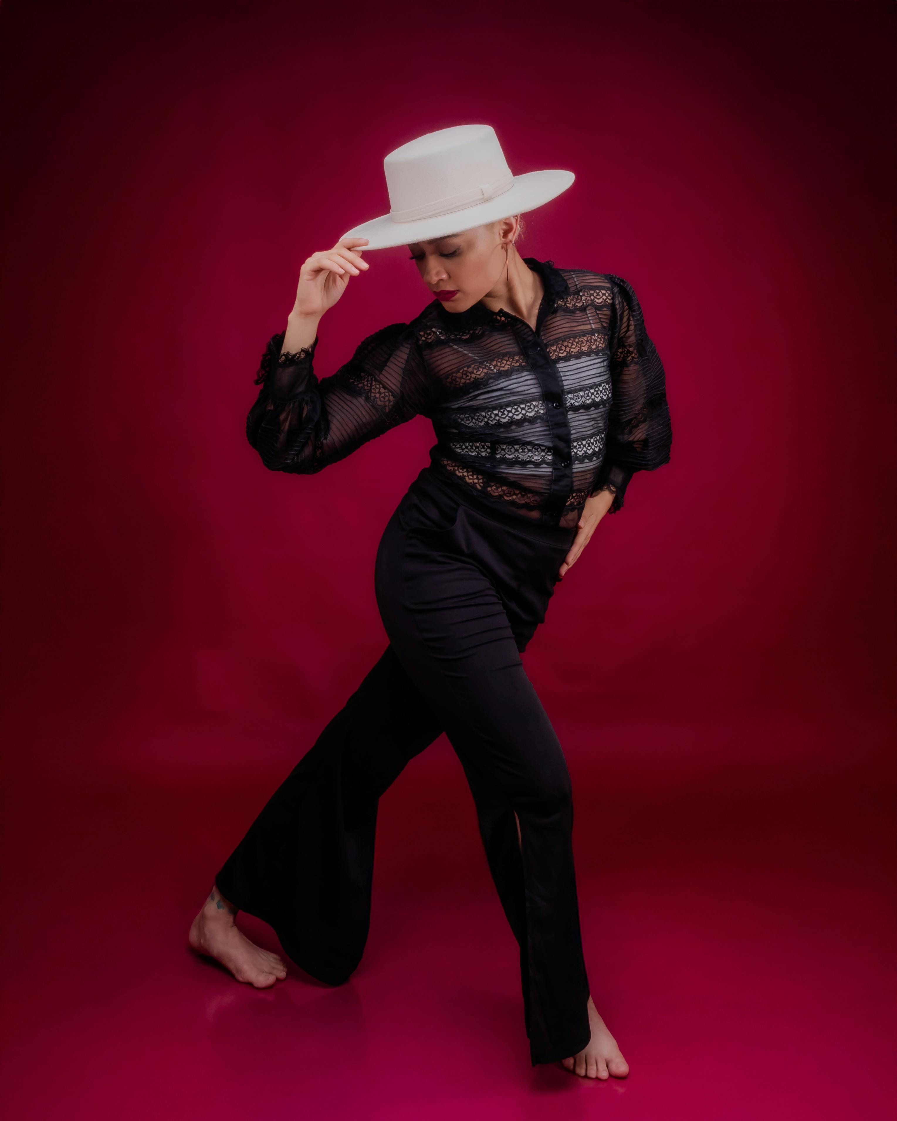 Elegant Female Dancer in Traditional Hat · Free Stock Photo