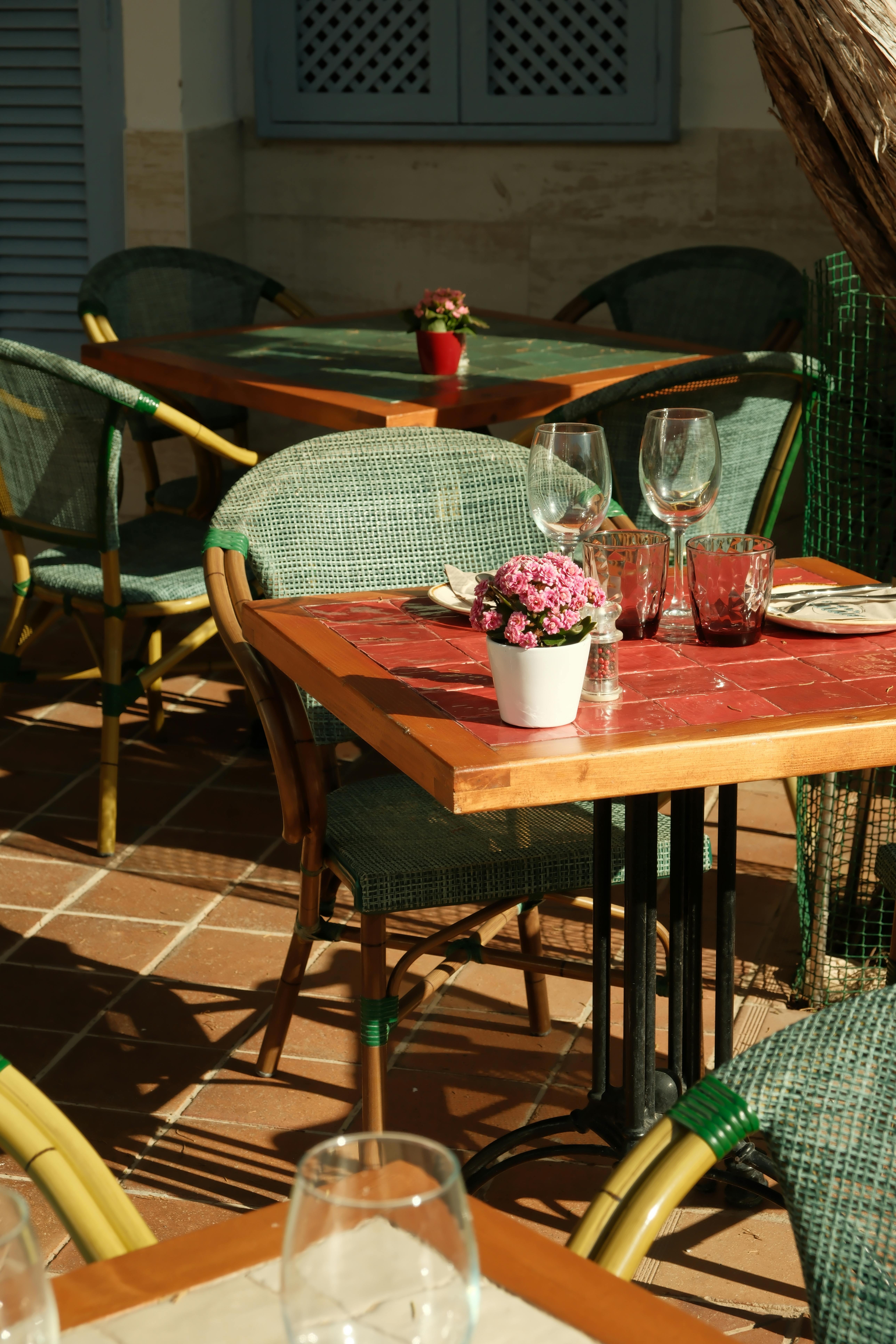 Cozy Outdoor Cafe Setting in Cala d'Or Sunlight · Free Stock Photo