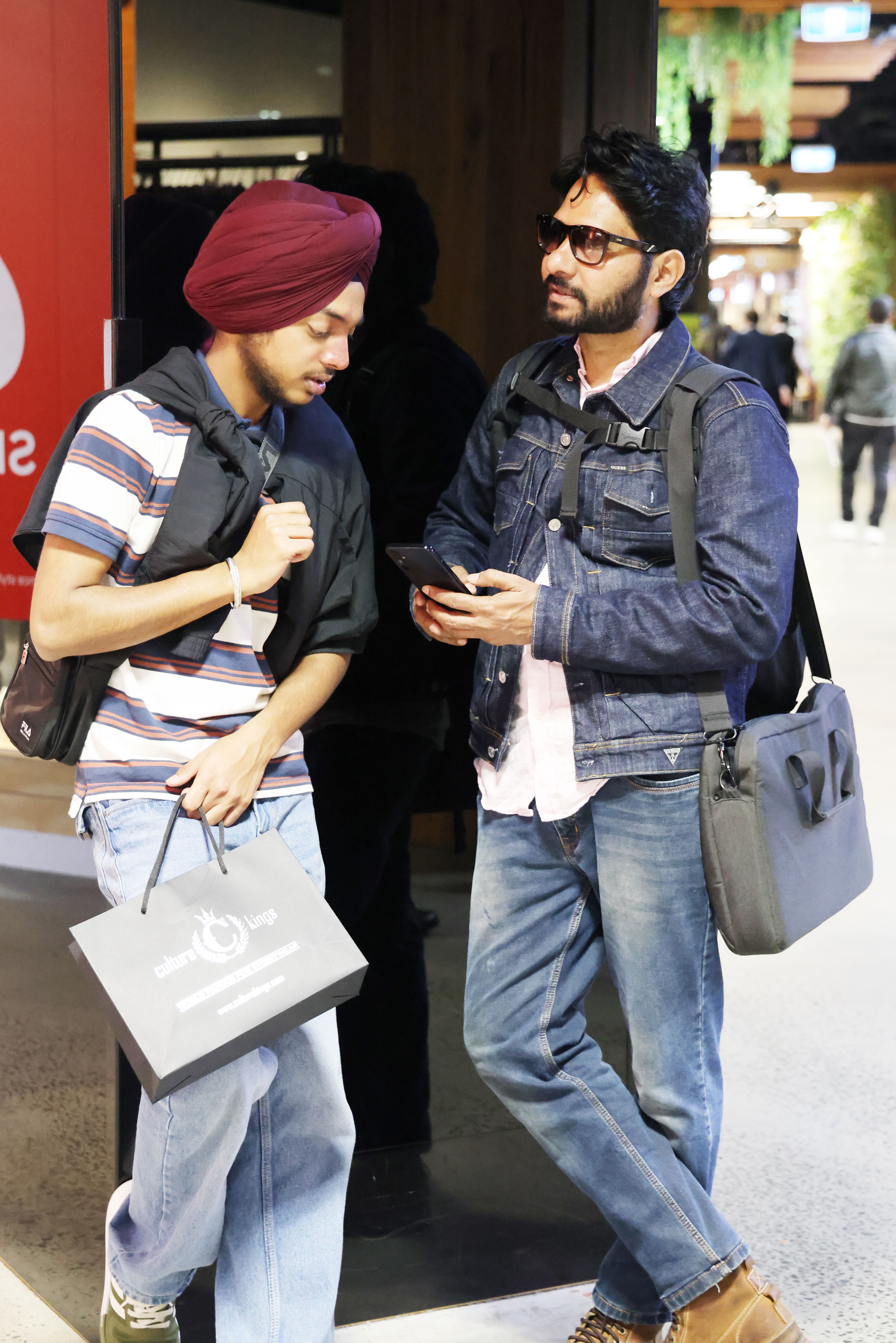 Two Men Shopping in Urban Mall Setting · Free Stock Photo