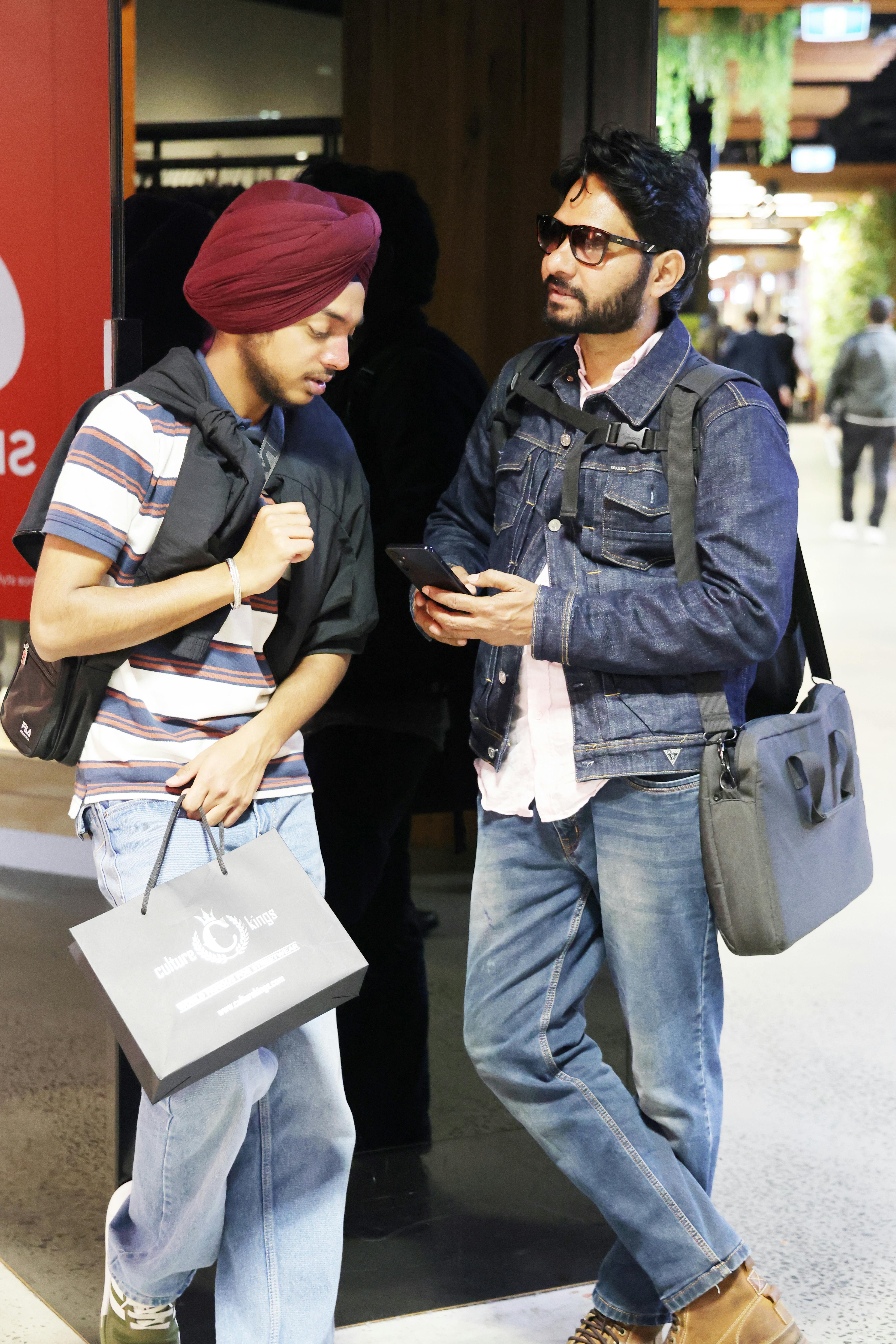 Two Men Shopping in Urban Mall Setting · Free Stock Photo