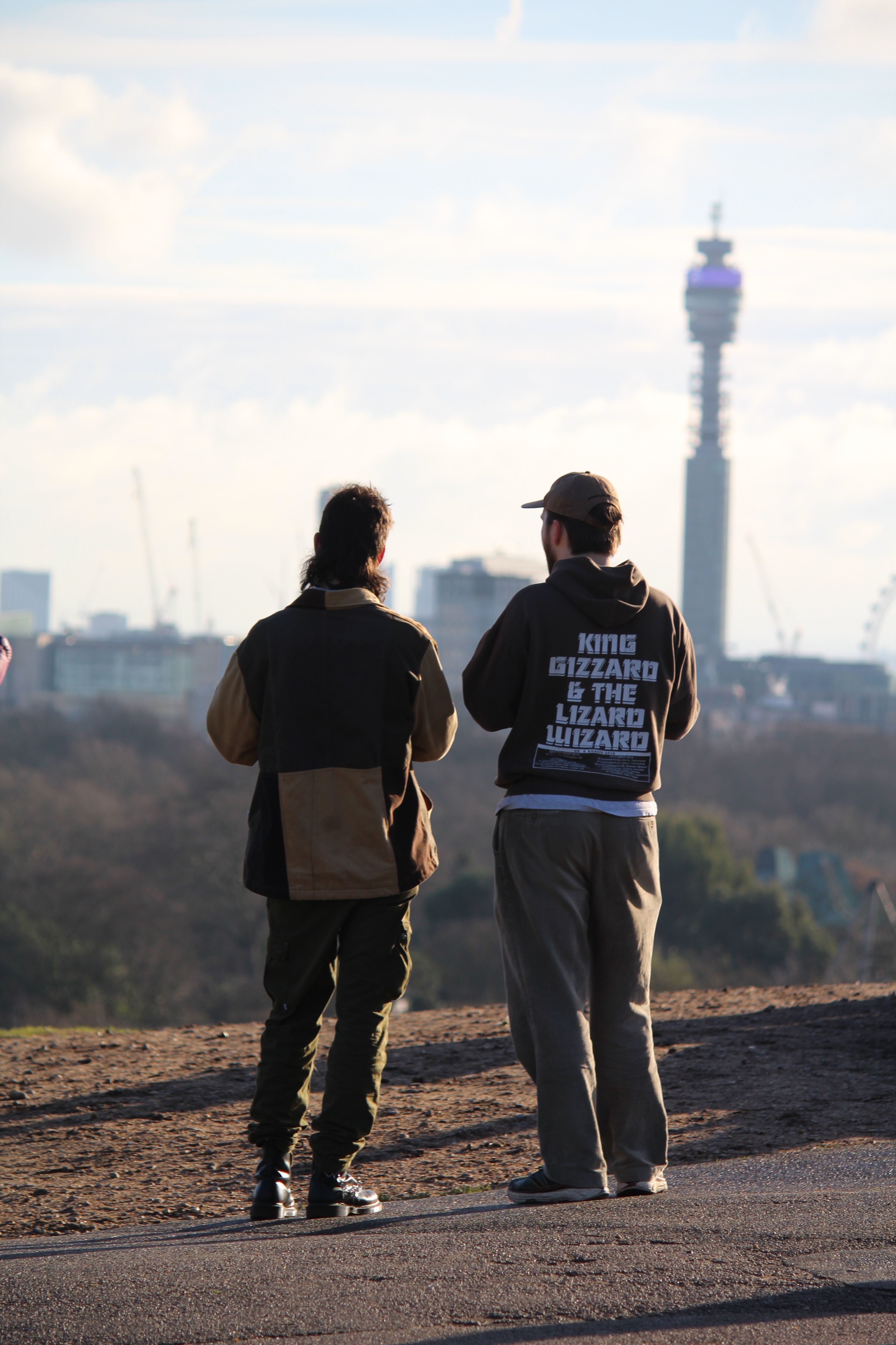 Two People Overlooking City Skyline at Daytime · Free Stock Photo