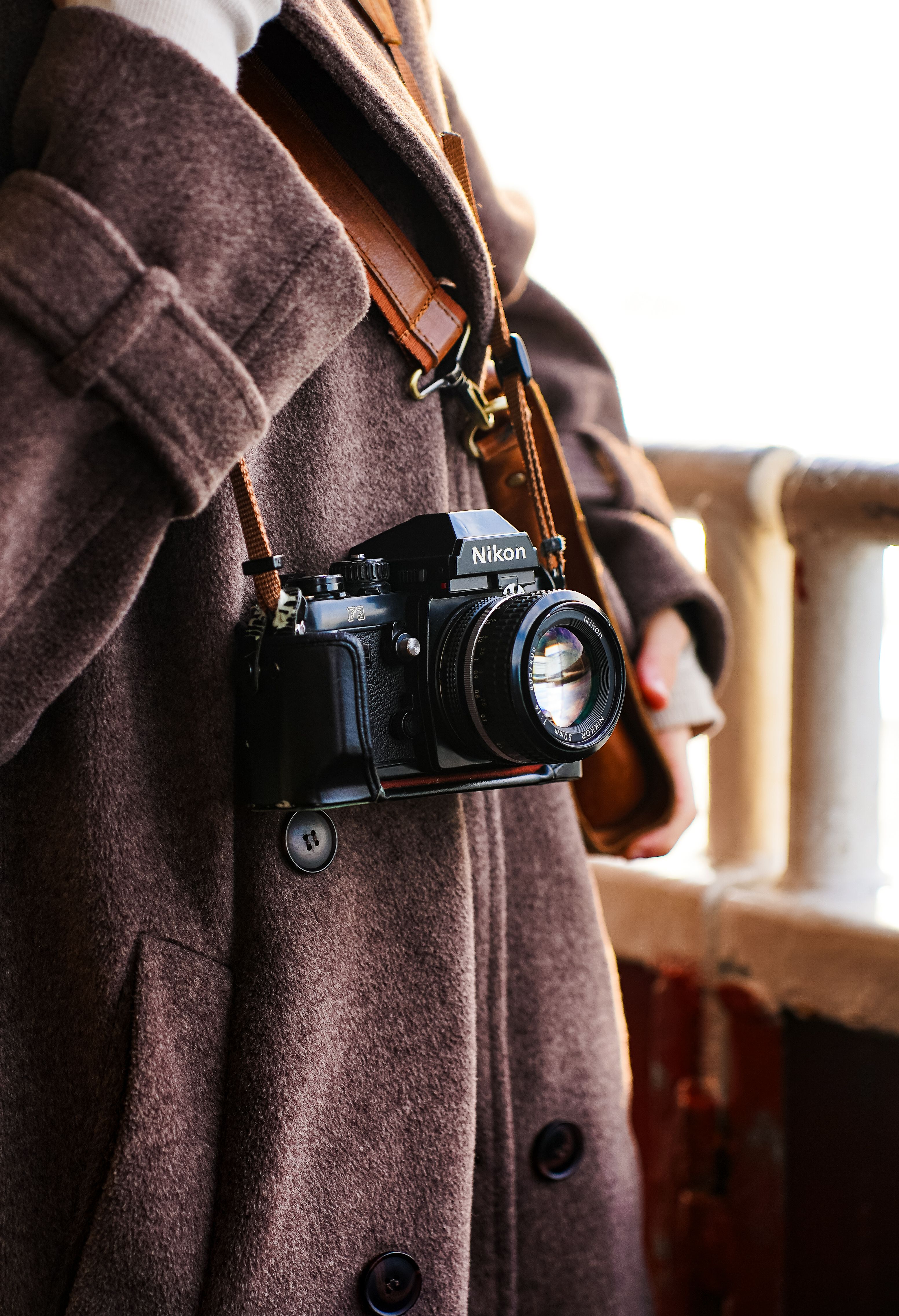 Vintage Camera on Brown Coat Outdoors · Free Stock Photo
