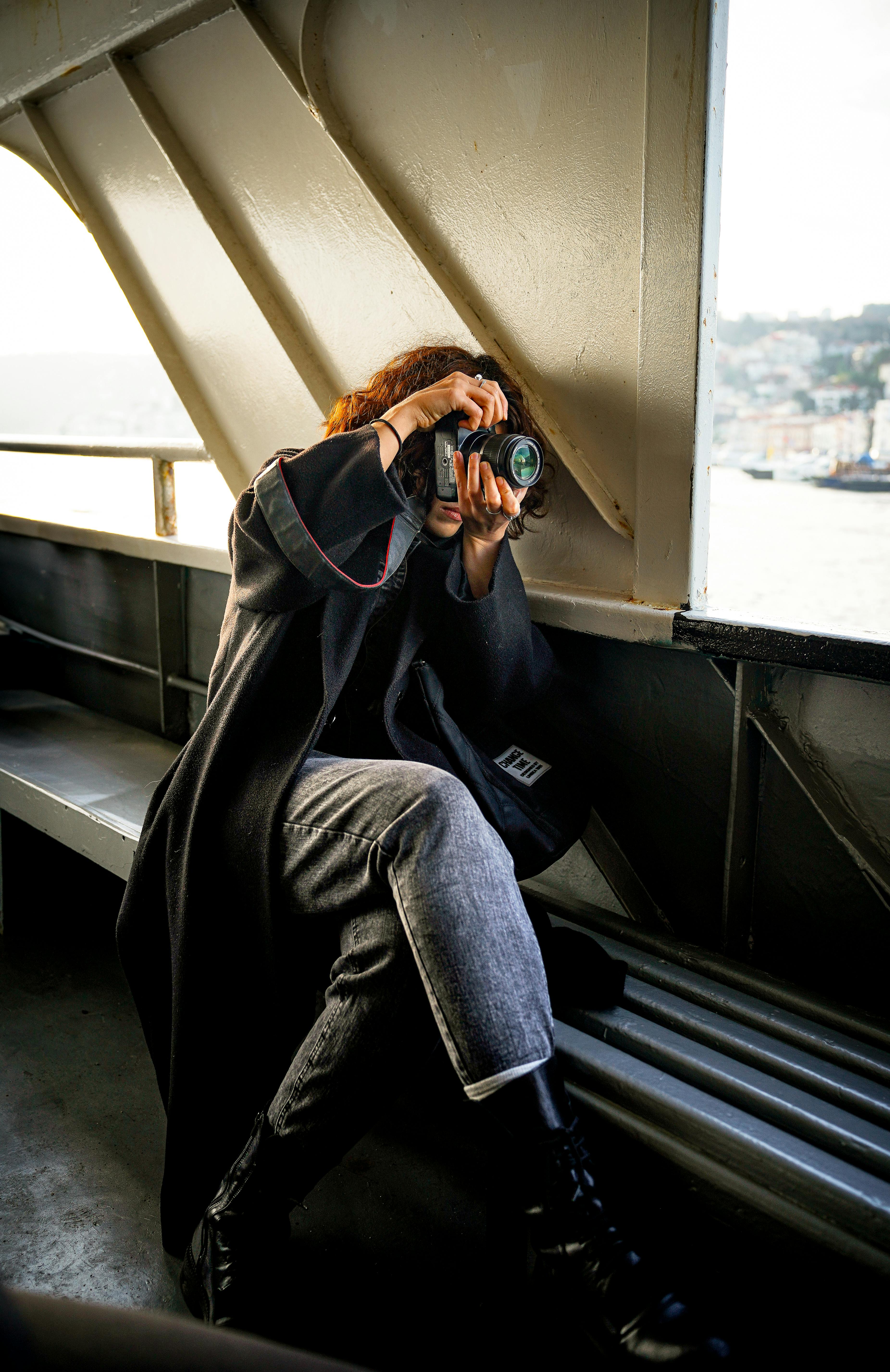 Photographer Capturing View on a Ferry Ride · Free Stock Photo