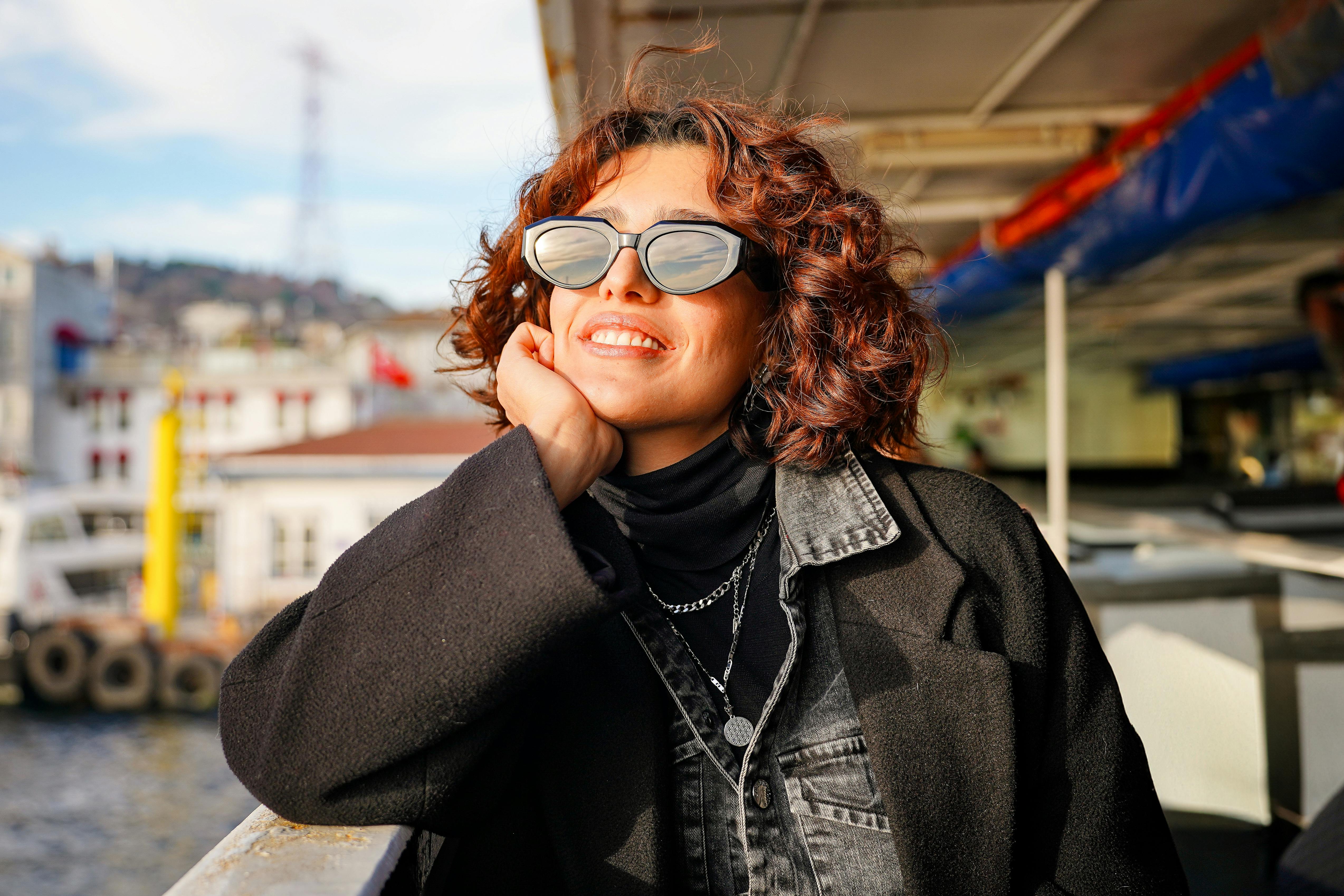 Stylish Woman Relaxing on a Ferry Ride · Free Stock Photo