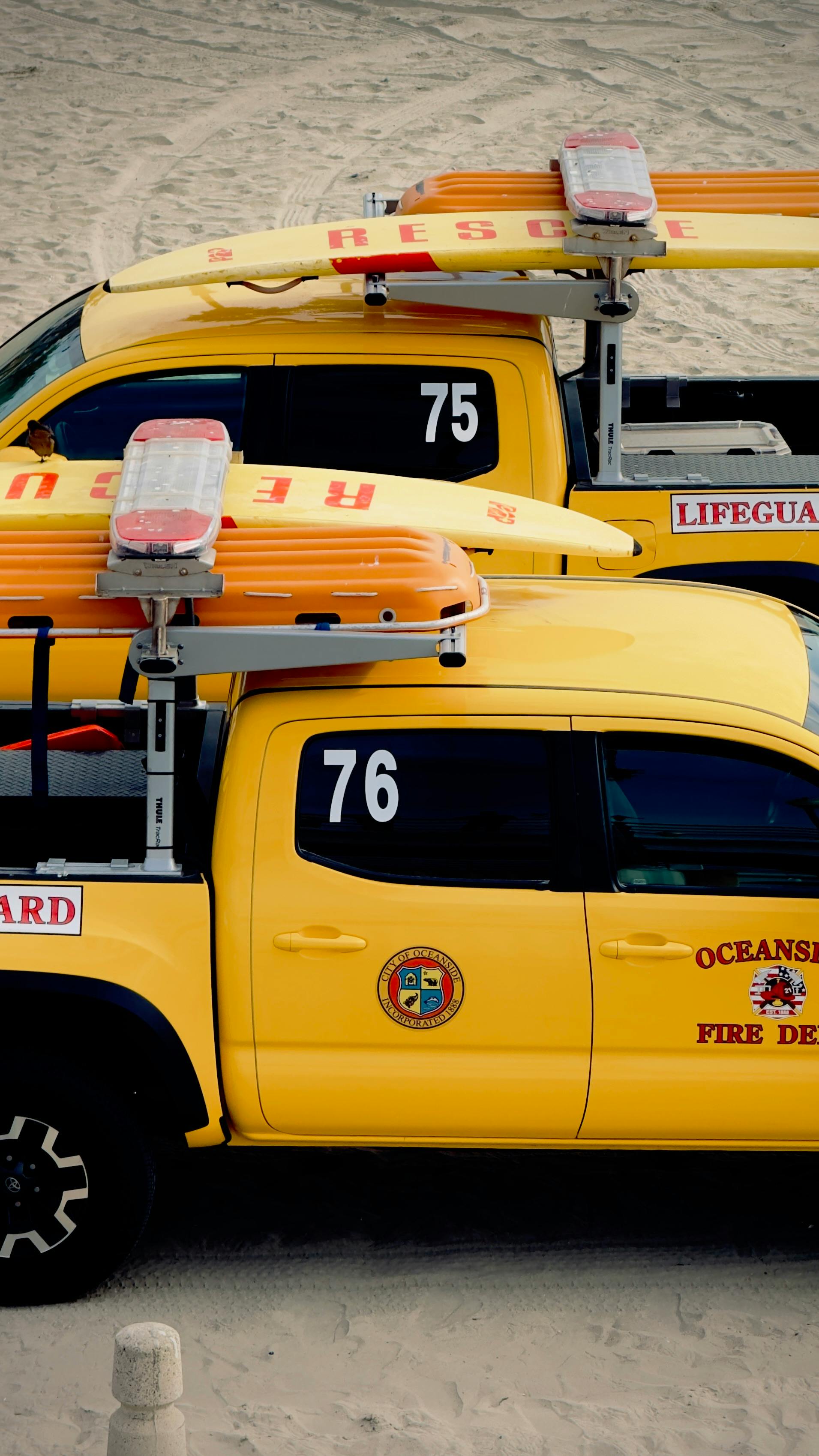 Oceanside Lifeguard Trucks on Sandy Beach · Free Stock Photo