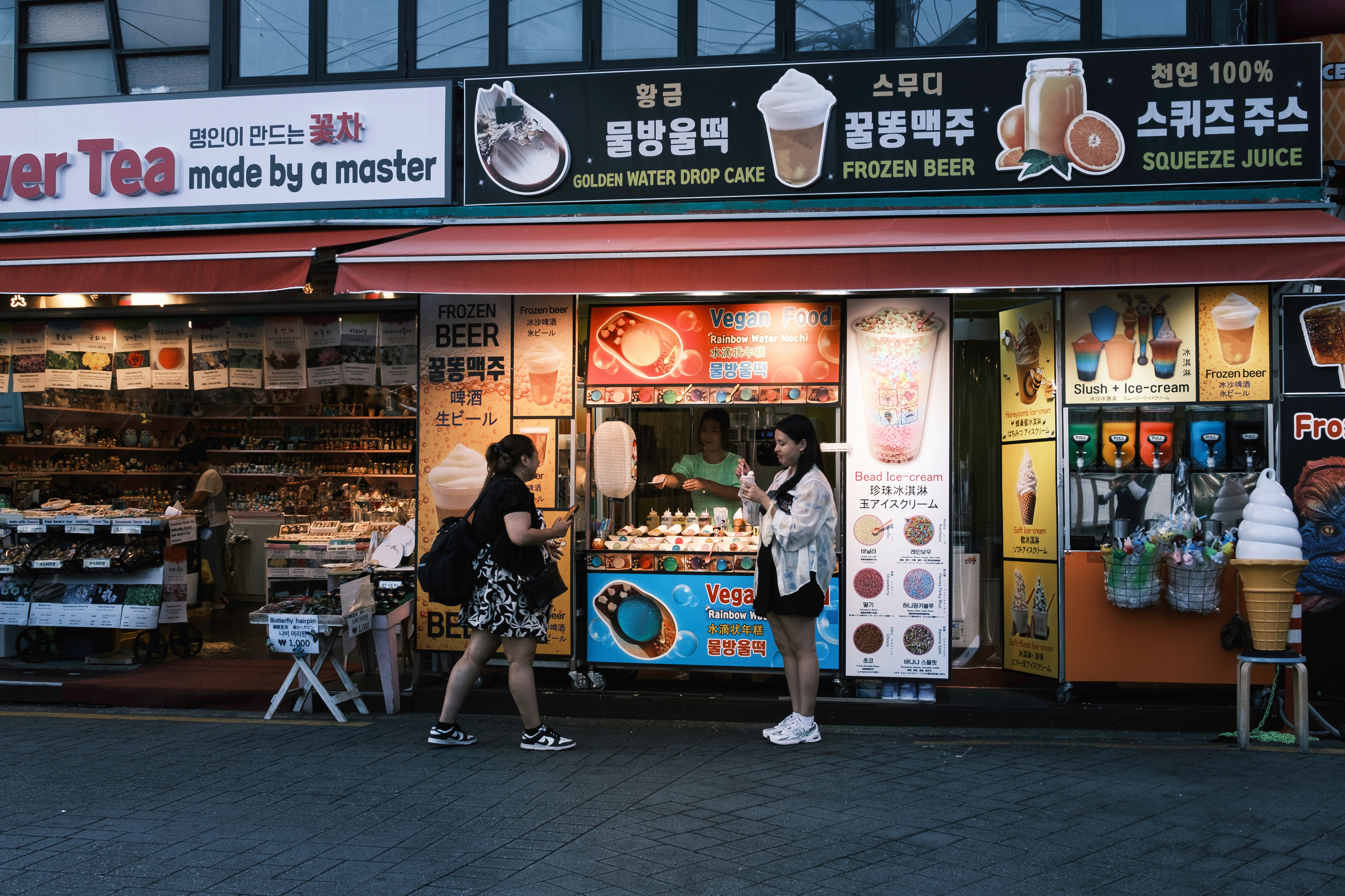Street Food Stand with Colorful Menu Signs at Dusk · Free Stock Photo