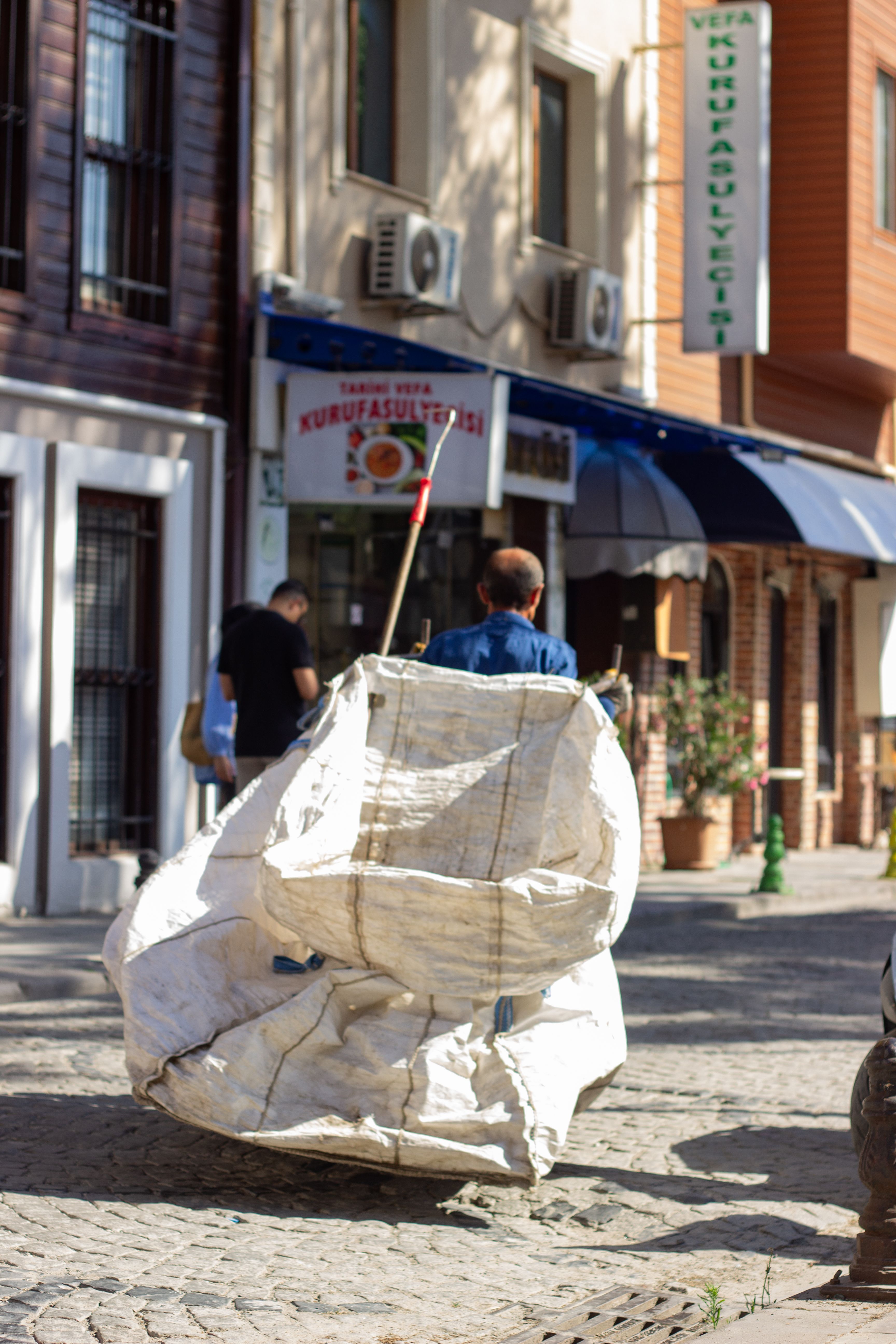 Urban Street Scene with Large Bag Carrier · Free Stock Photo